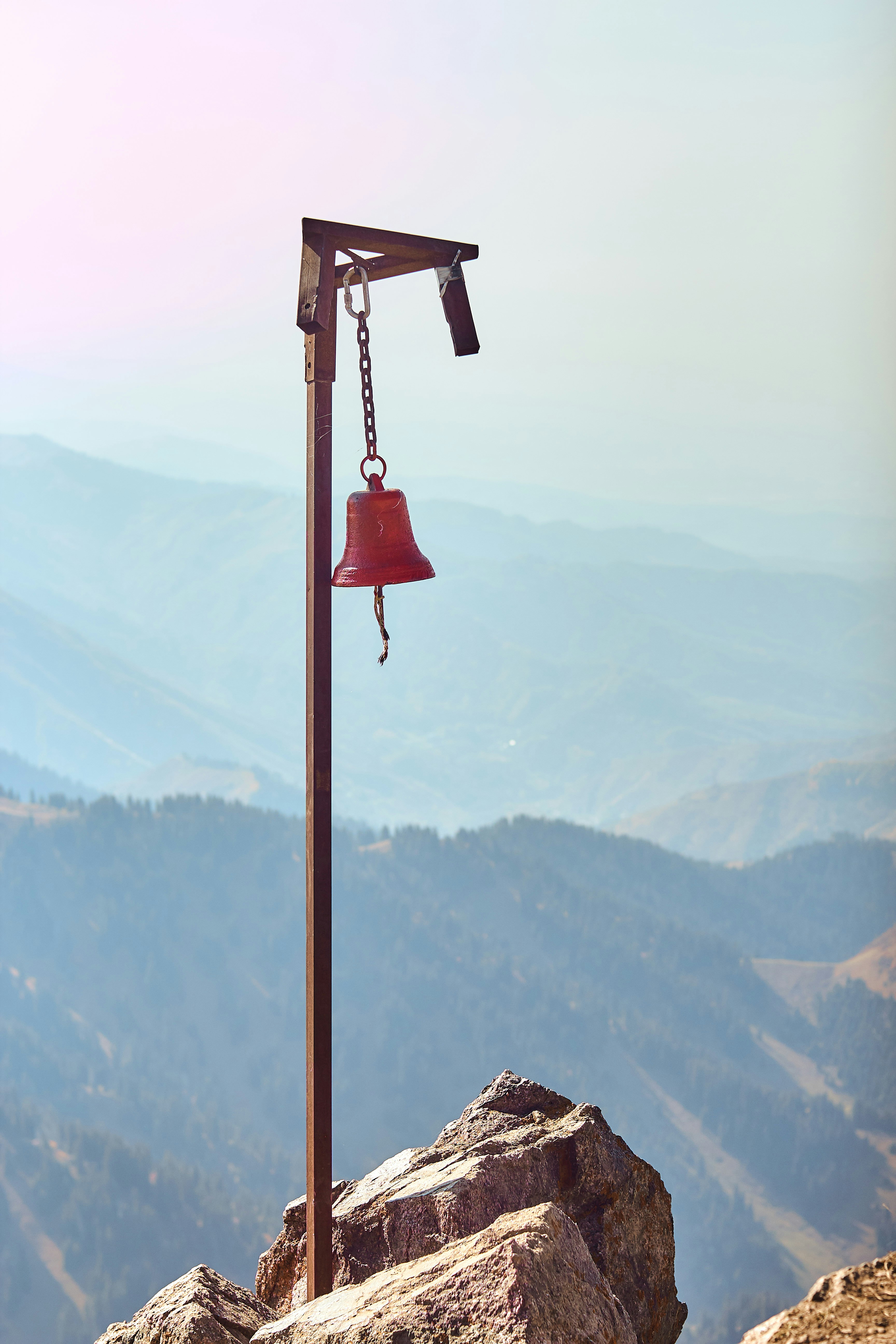 a red bell on a pole