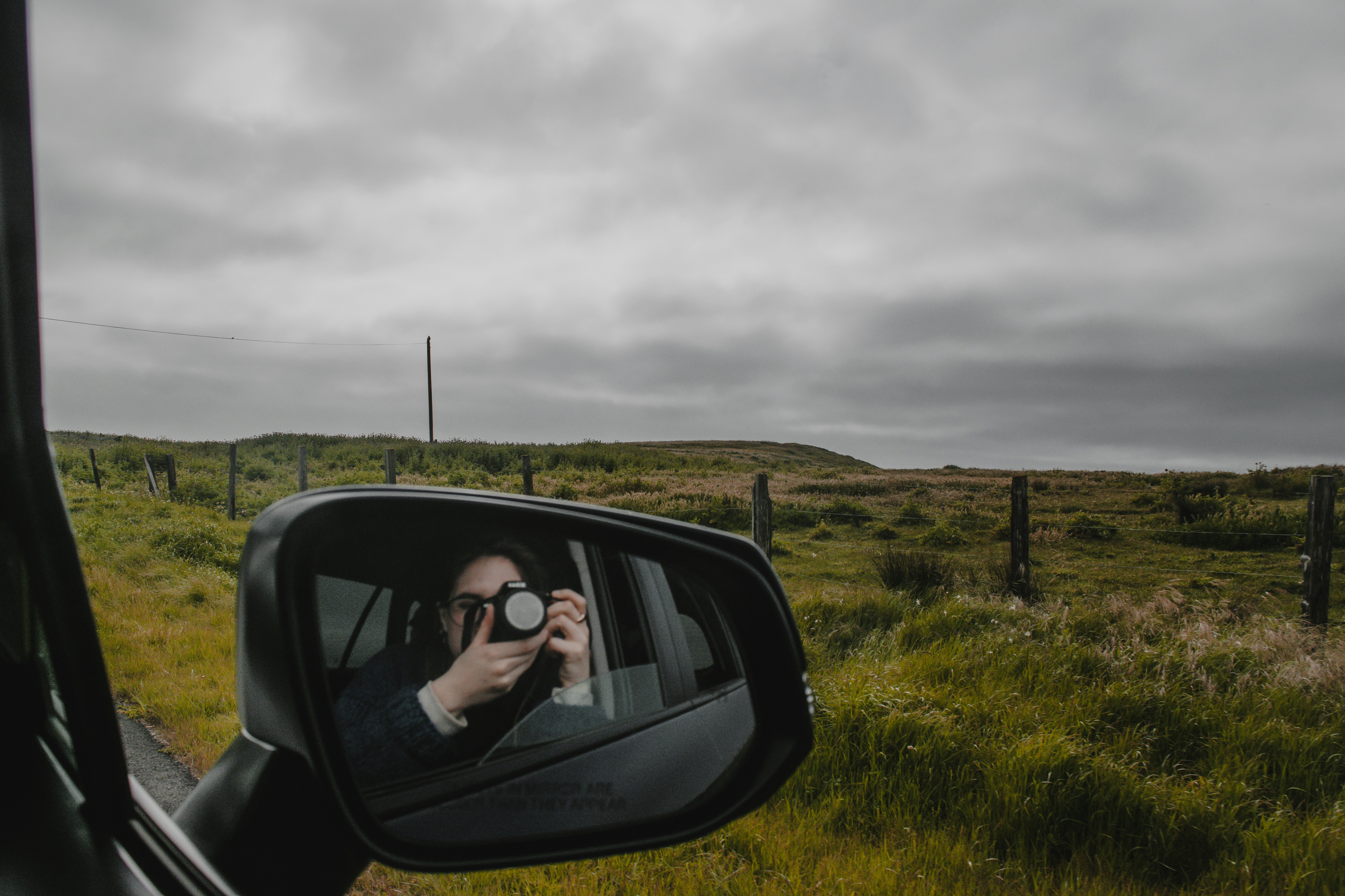 Mirror Portrait on a Windy Moor: The Photographer in Glass