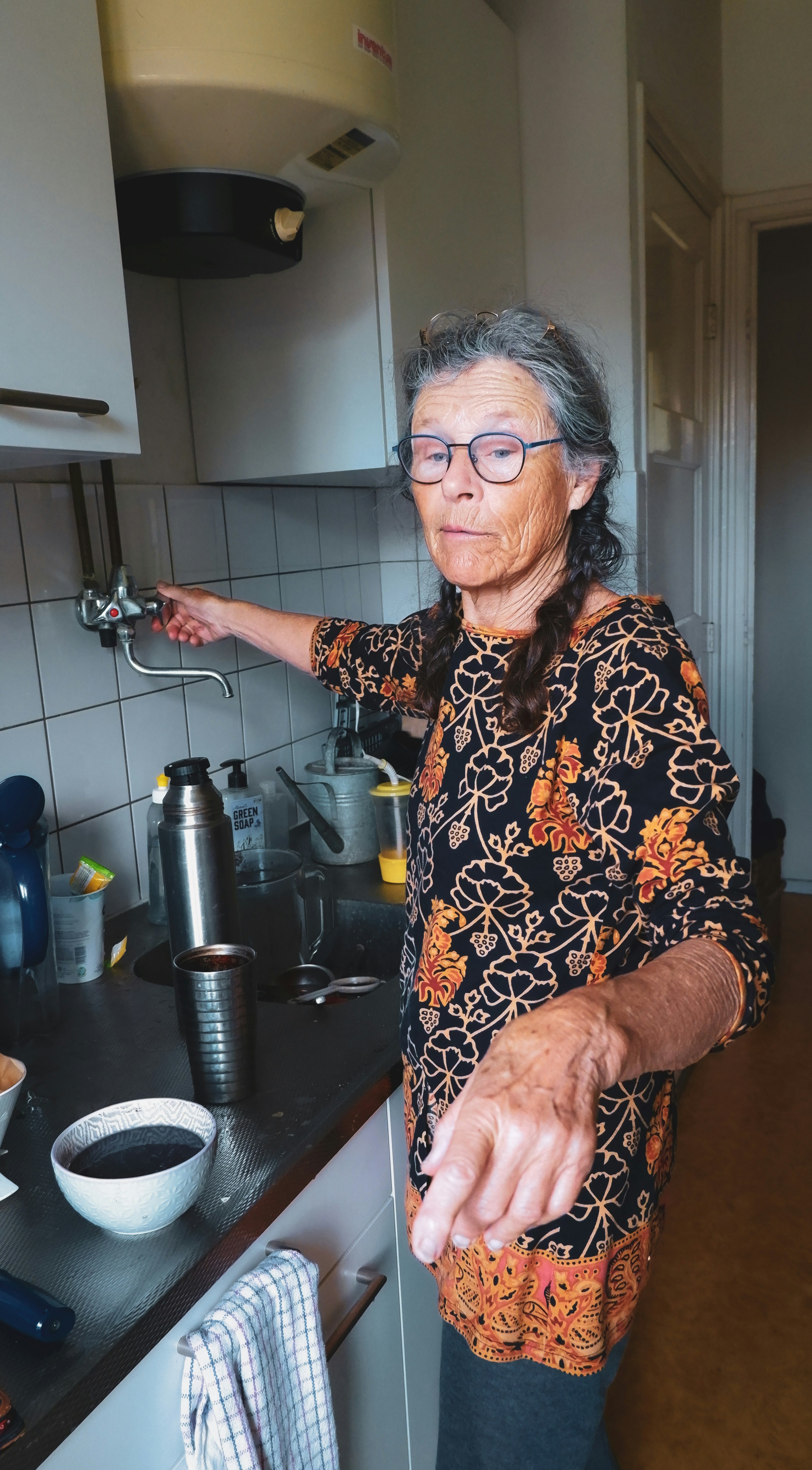 a man with tattoos in a kitchen