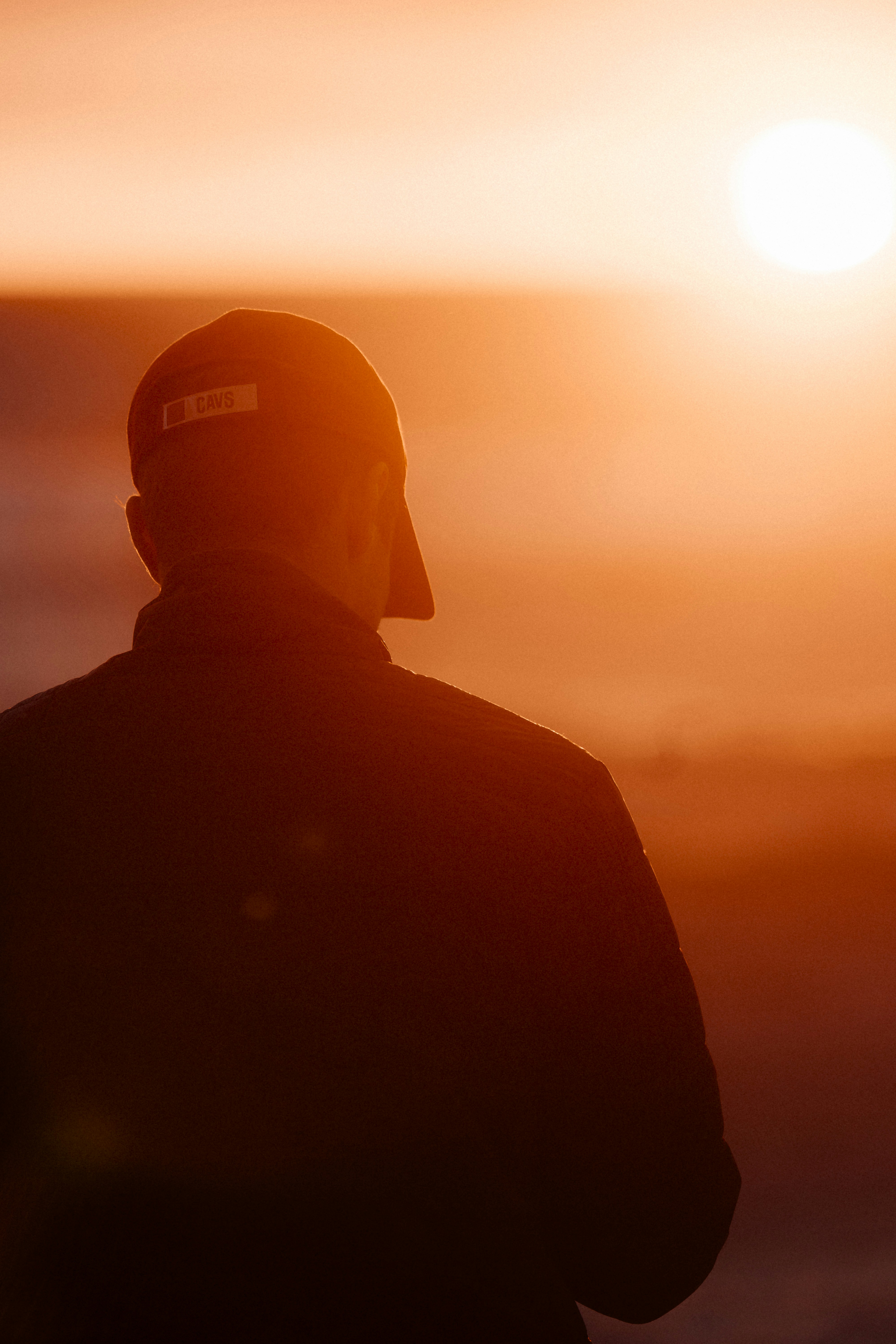 Backlit at Dusk: The Silhouette of a lone sailor against a molten horizon
