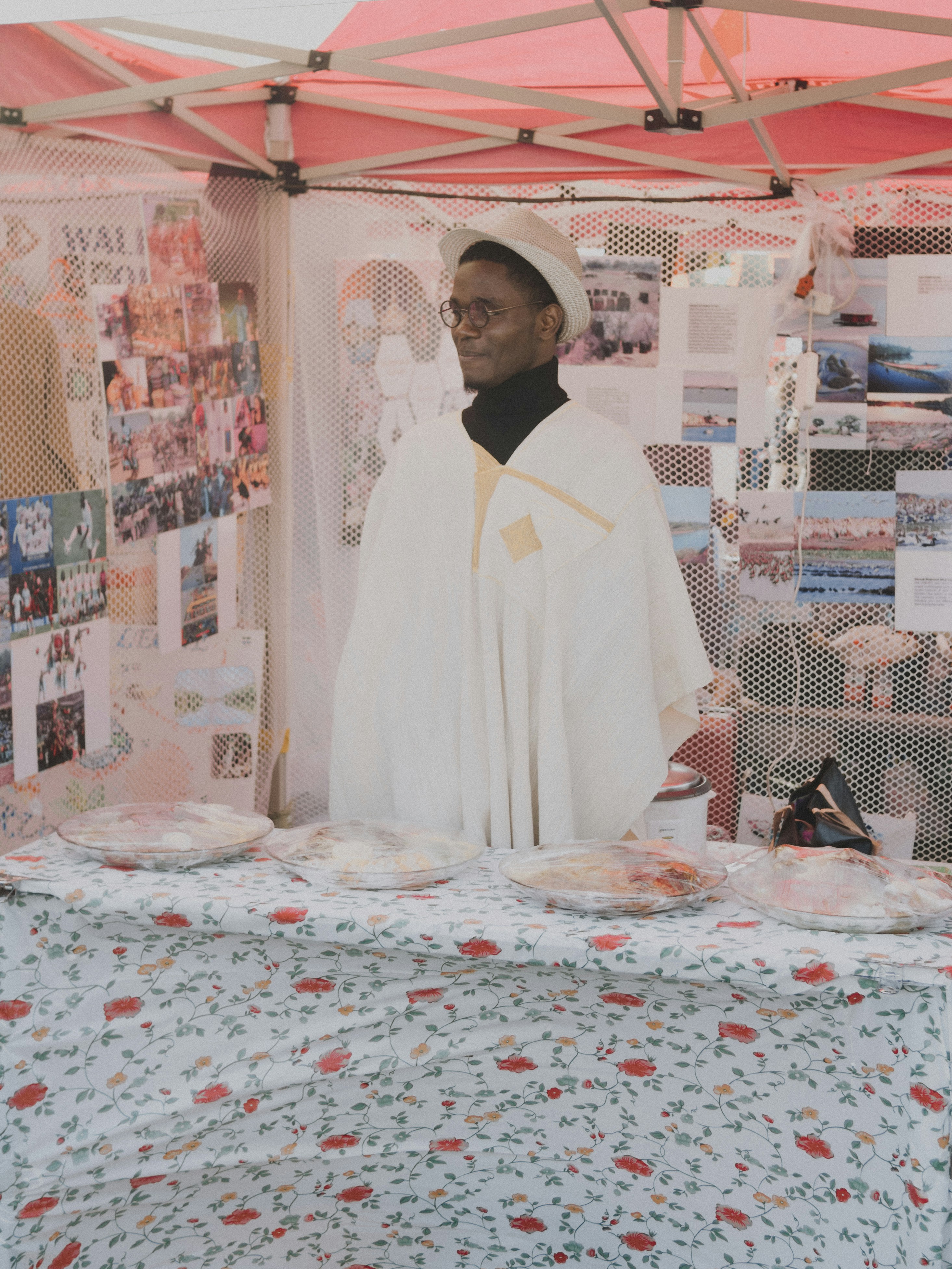 Under the Coral Canopy: Portrait at a Market Stall
