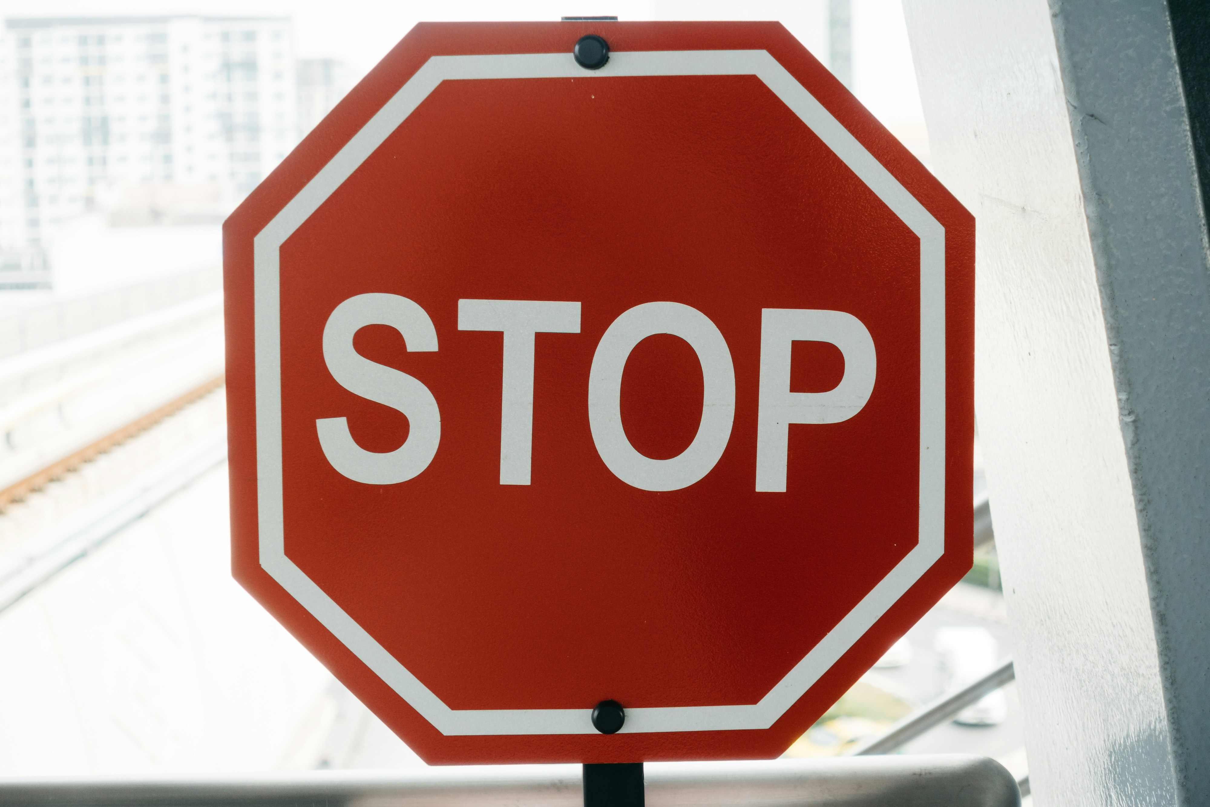 A stop sign on a pole photo – Free Brown Image on Unsplash