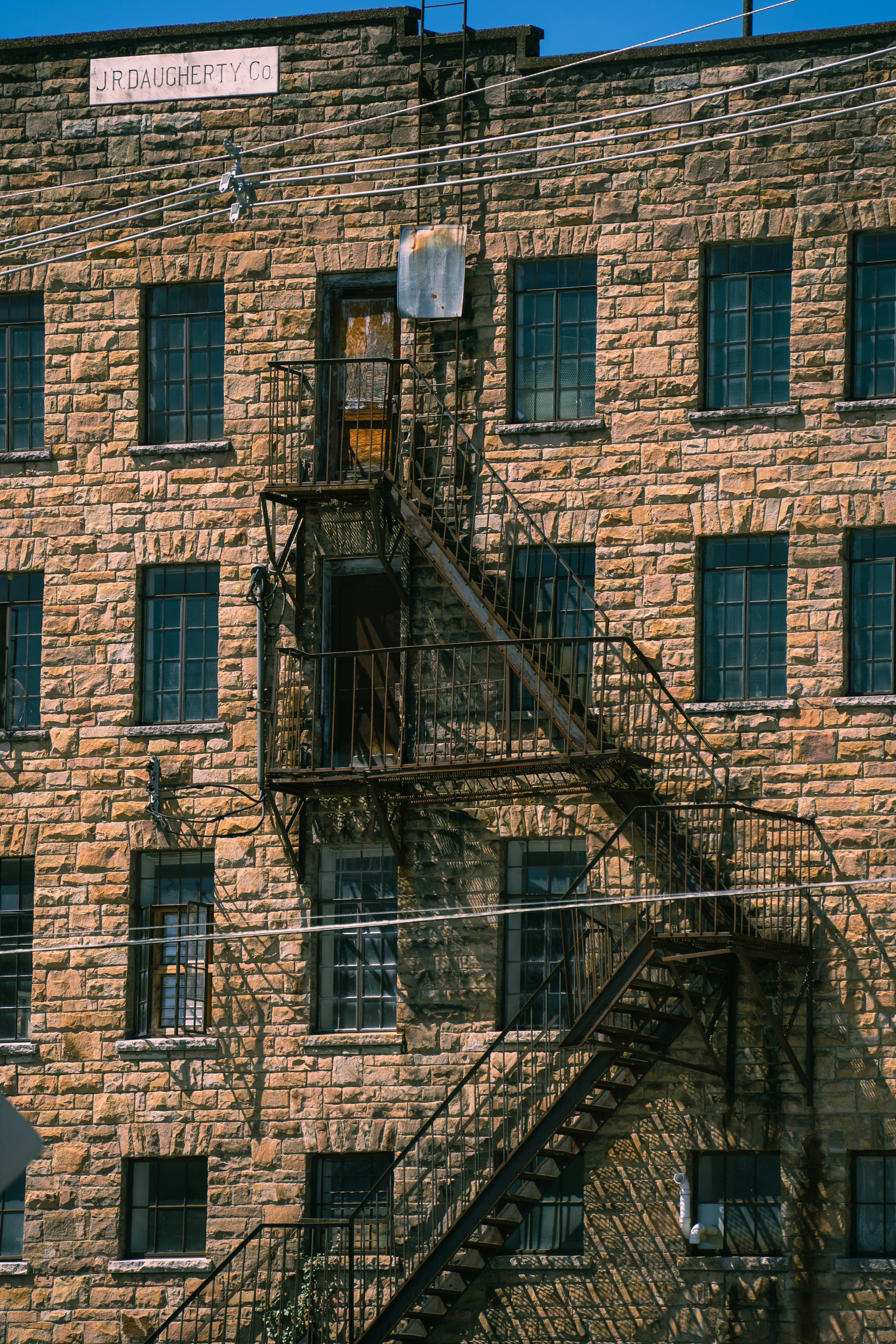Diagonal Fire Escape Framed by Weathered Brick Facade