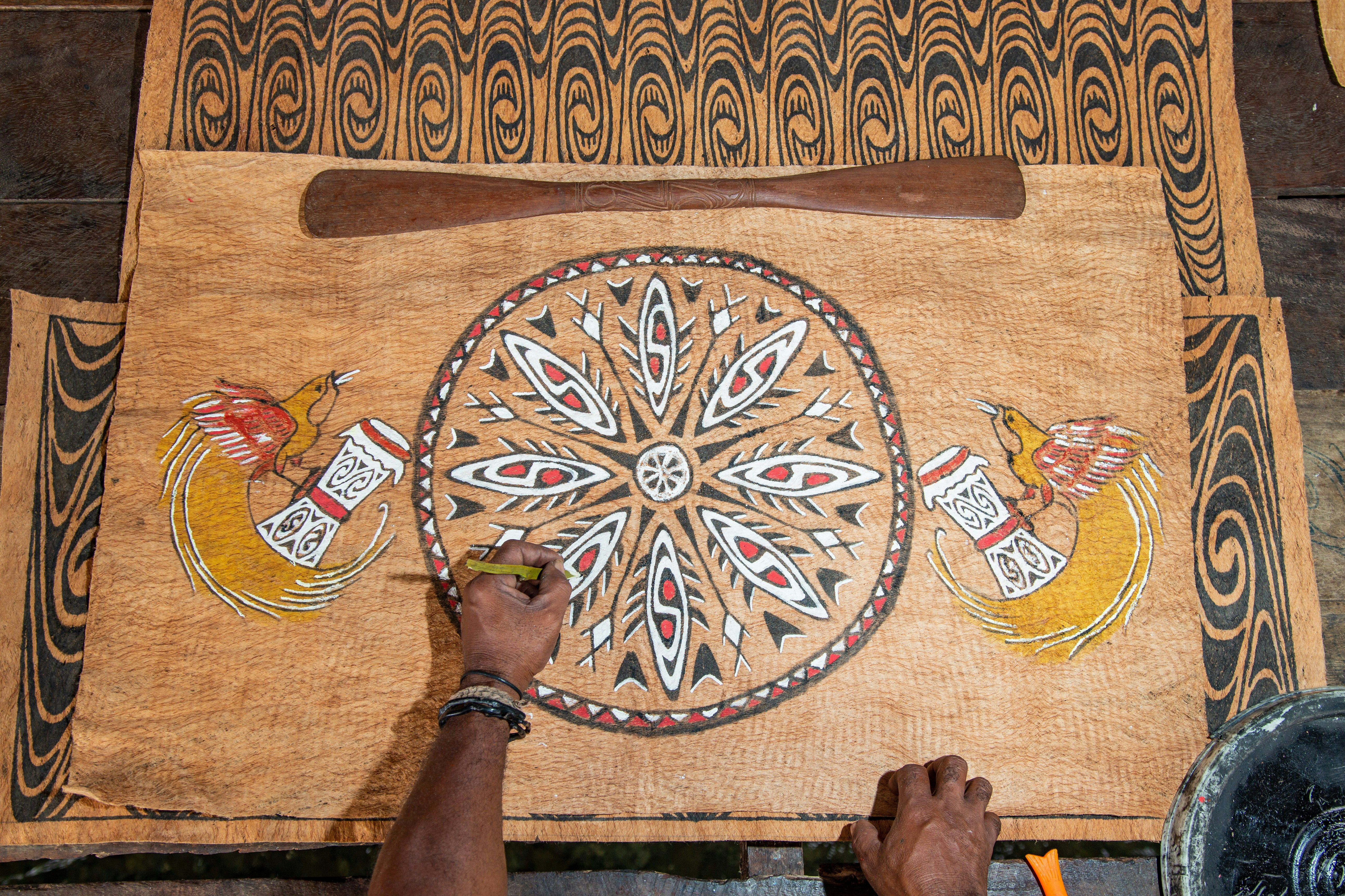 Mandala of Craft: Hands at Work on an Ornamental Wooden Panel