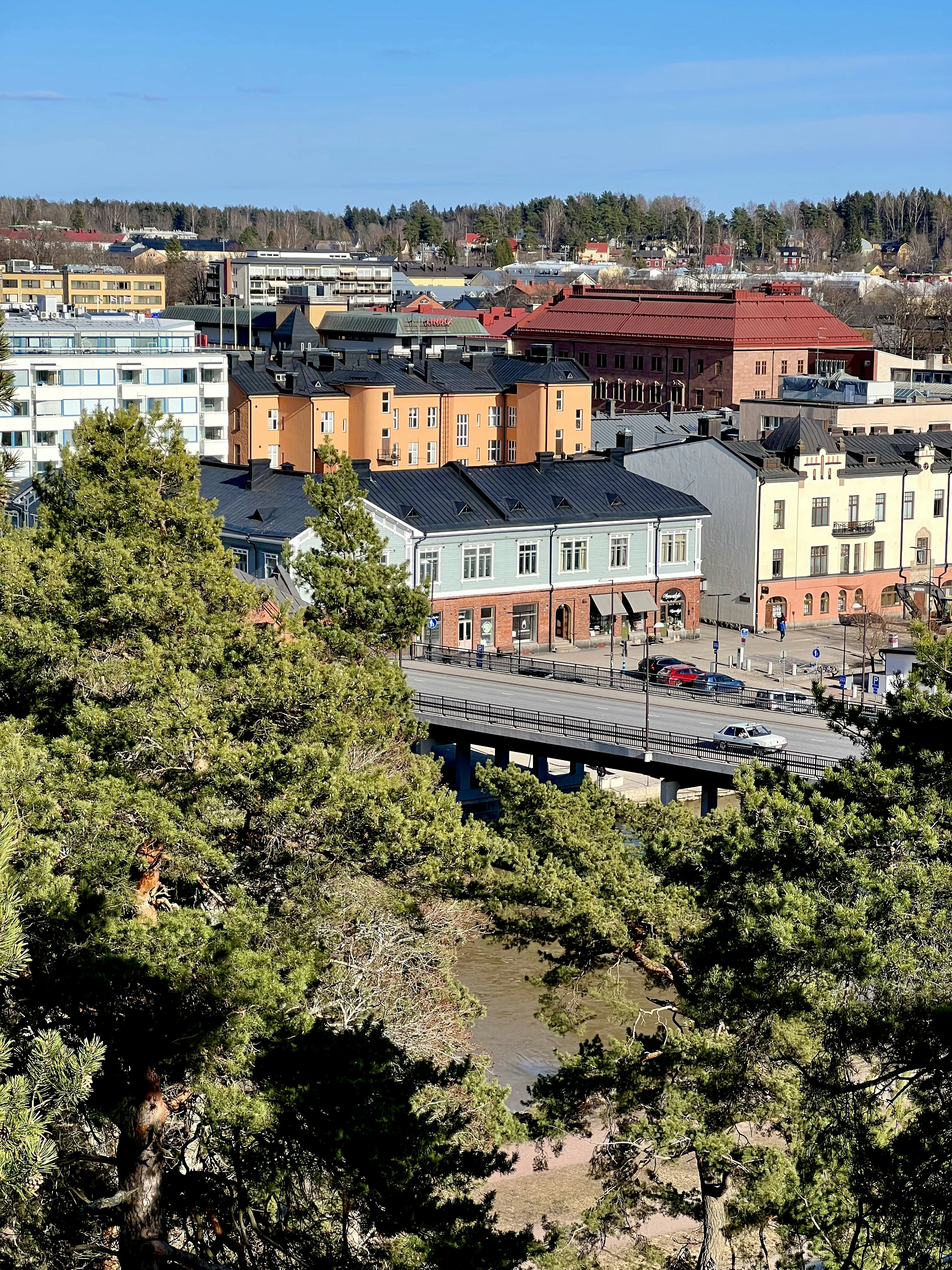 View of a vibrant urban landscape featuring a mix of colorful buildings and greenery, showcasing the intersection of nature and city life.