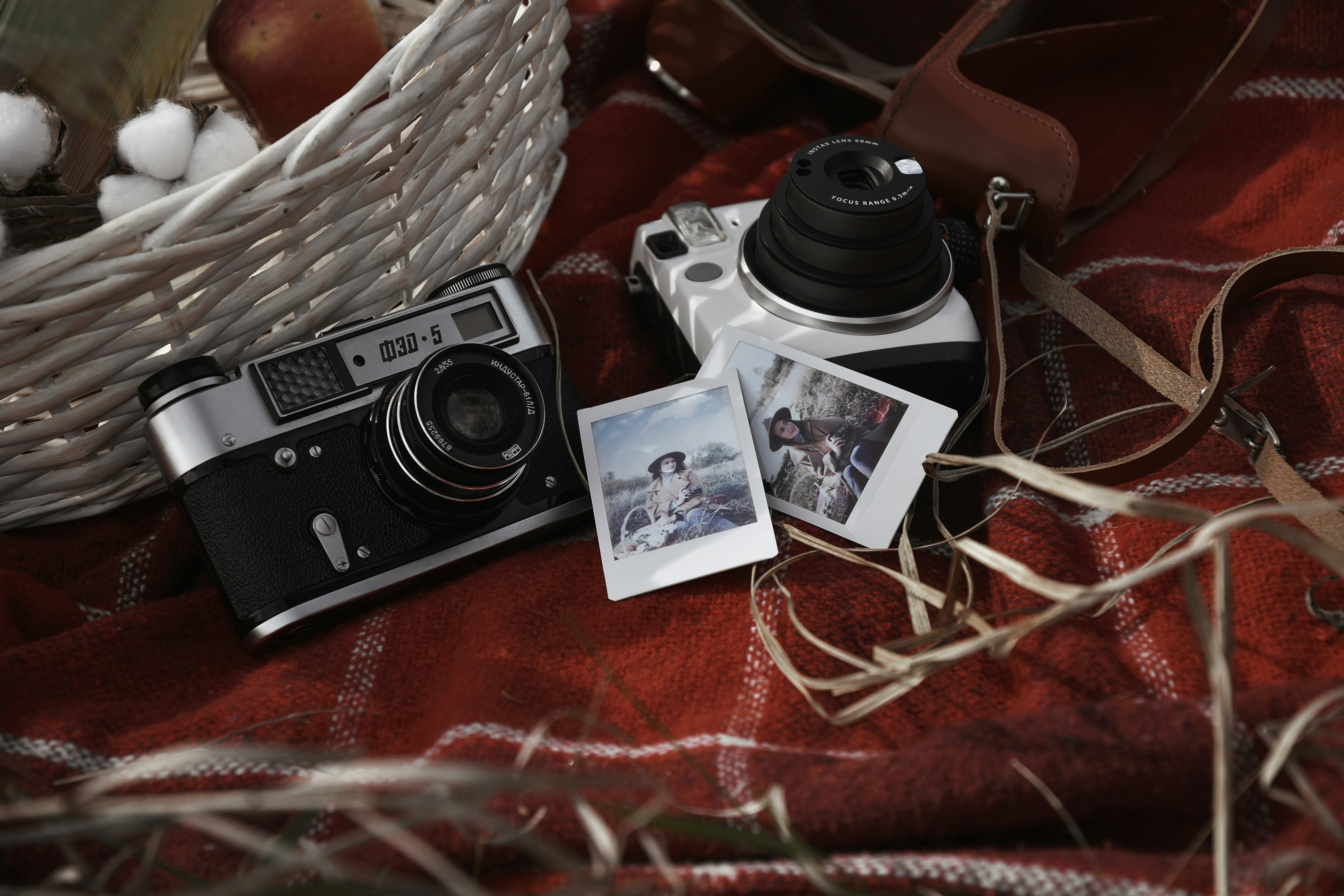 Retro Glass: A Pair of Classic Cameras Nestled on a Red Blanket
