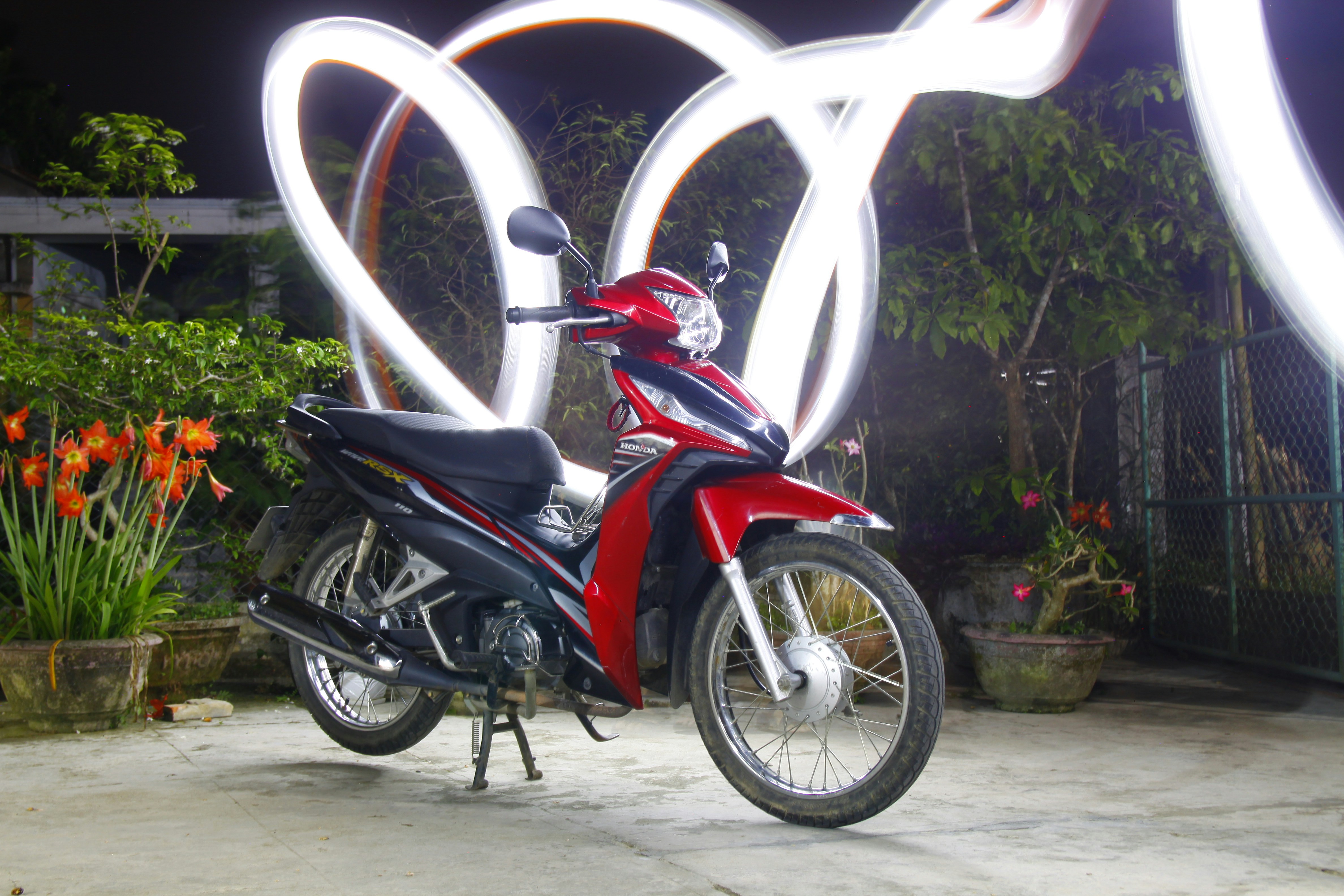 A motorcycle parked in front of a gate photo – Free Long exposure Image ...