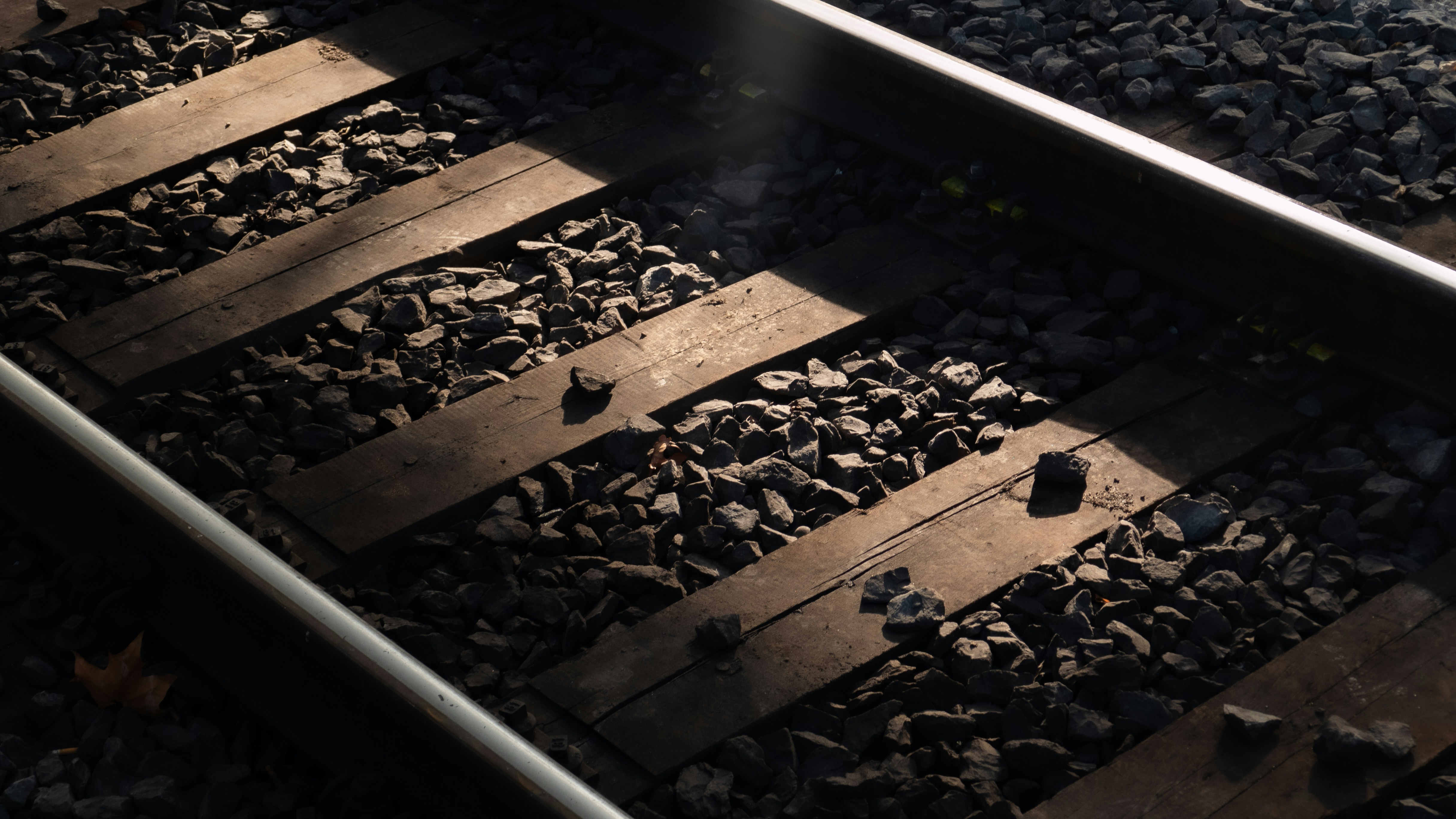 Sunlit Railbed: A Quiet Moment Between Ties and Gravel