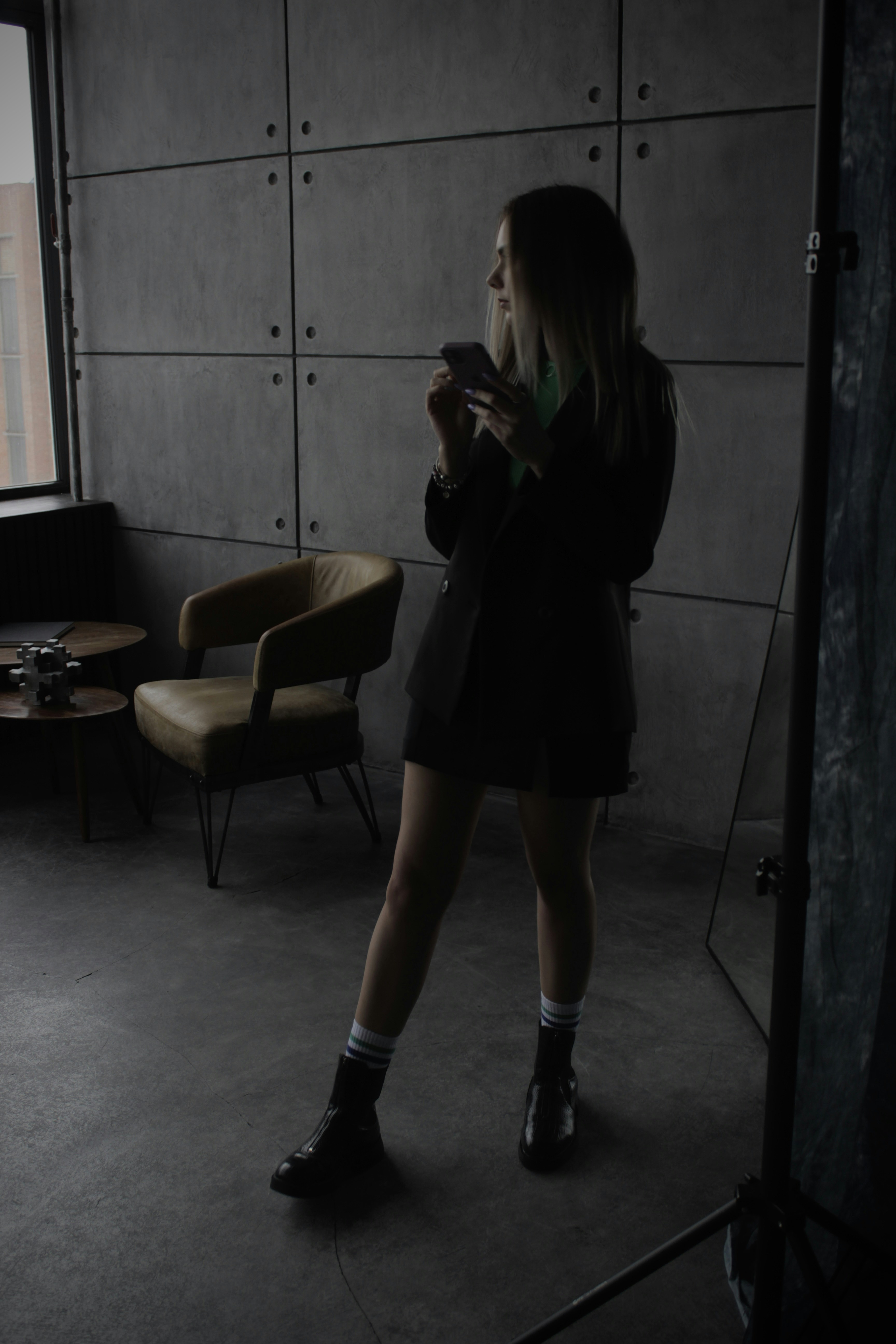 Silent Citylit Motif: A Woman in a Dim Loft with a Neon Edge