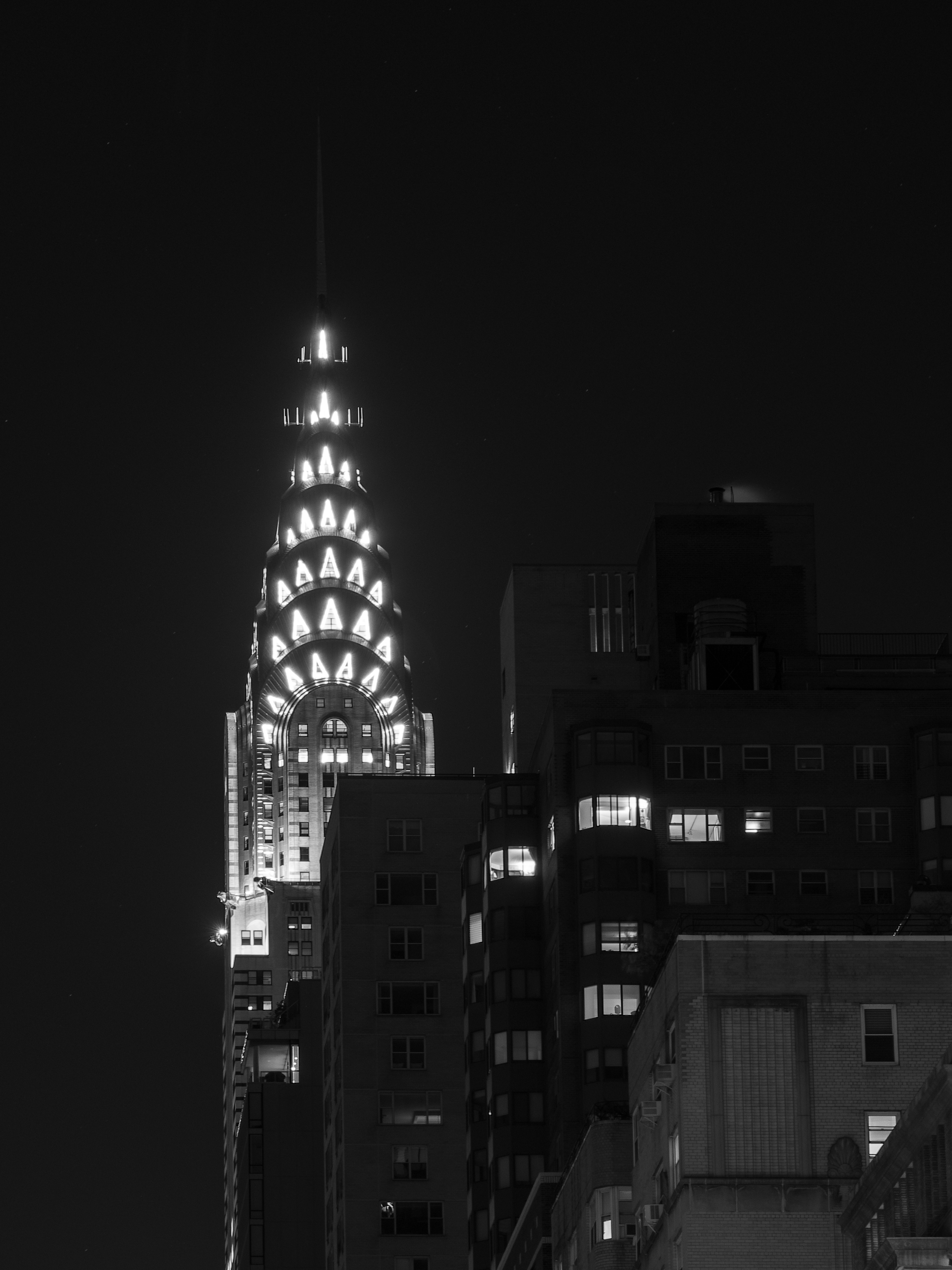 A tall building lit up at night photo – Free Chrysler building Image on ...