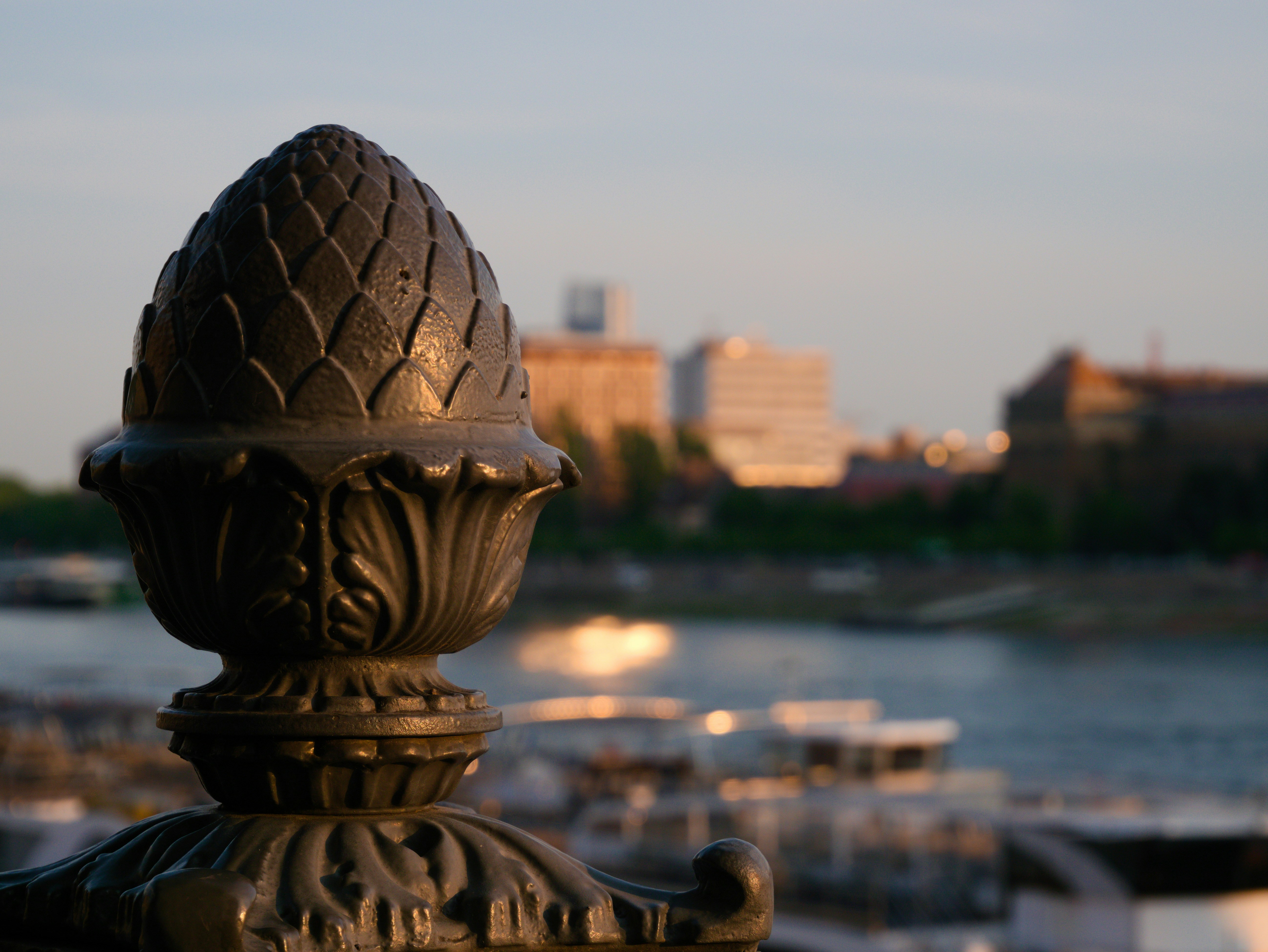 A statue on a railing overlooking a body of water photo – Free Closeup ...