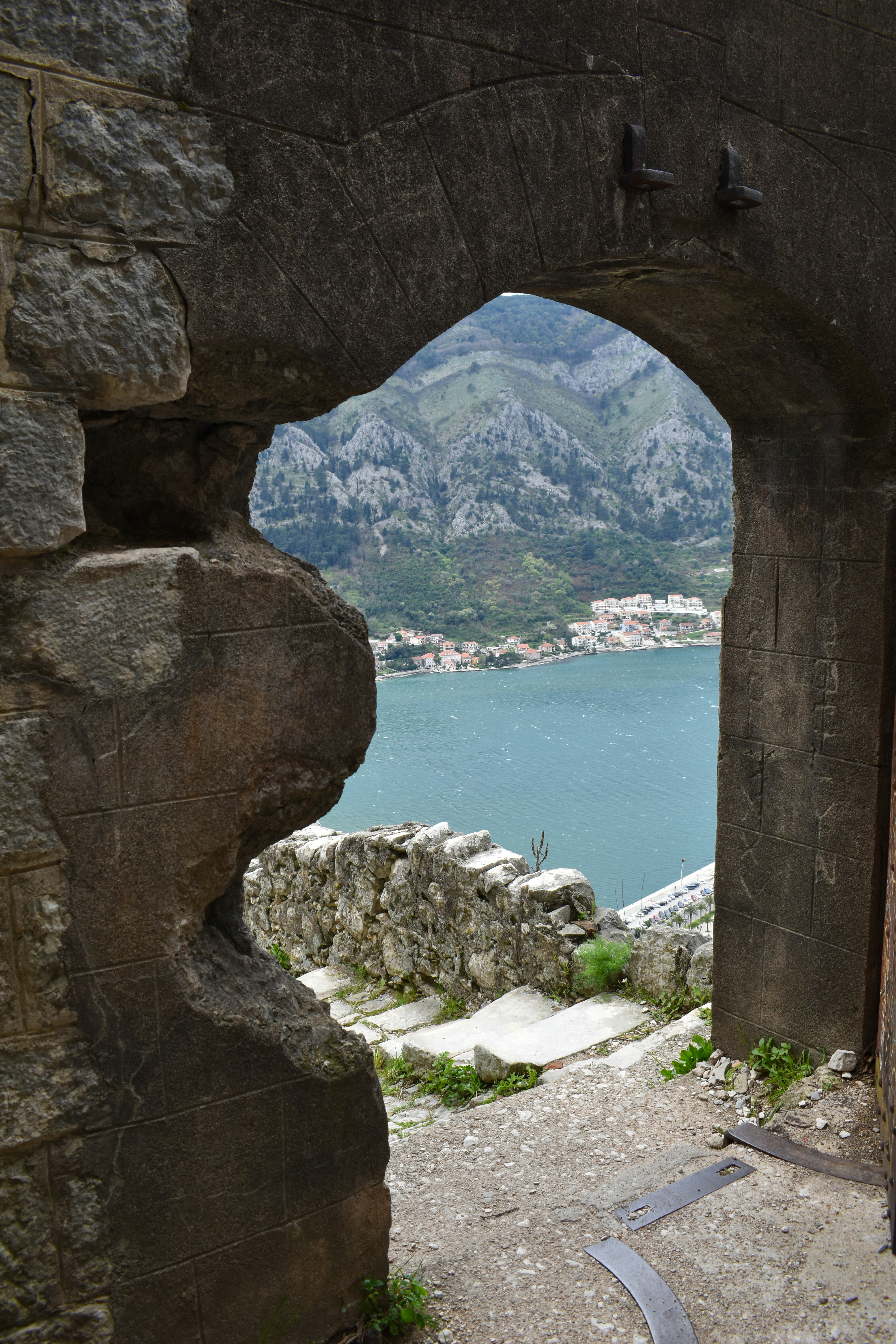 Through the Stone Arch: A Coastal Town Framed by Ancient Walls