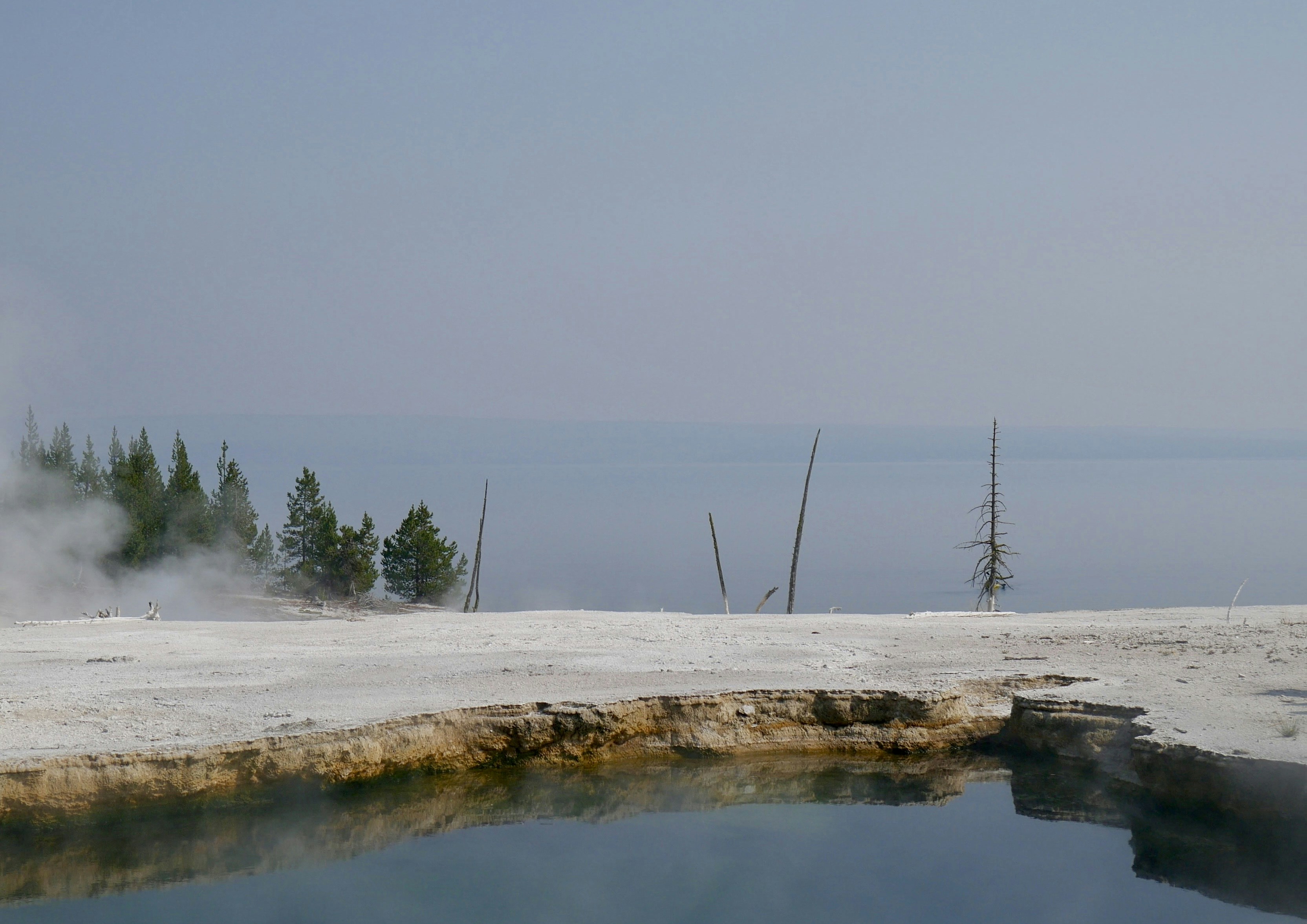 Steam Veins Over a Mineral Shore by the Quiet Blue Basin