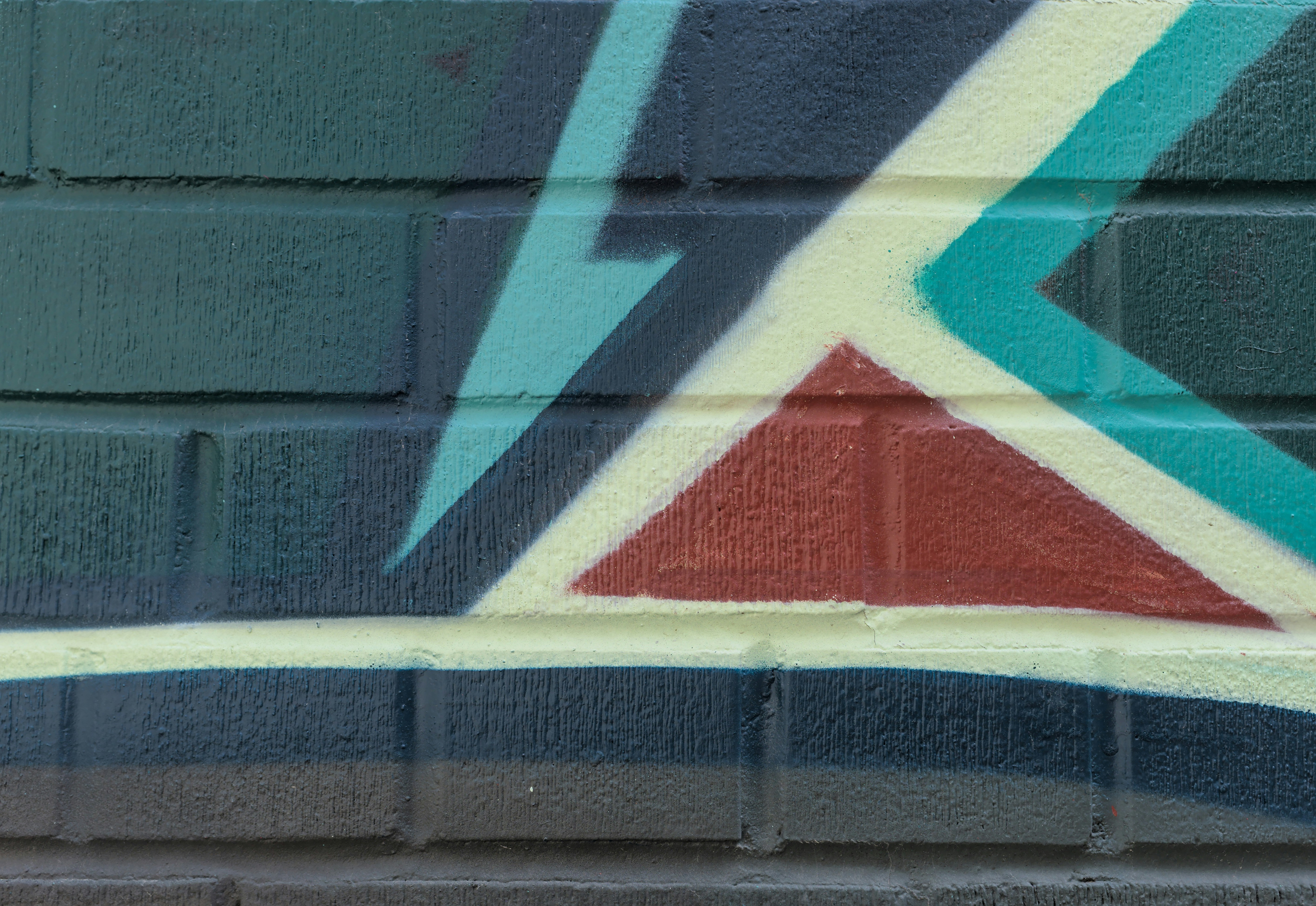 Crimson Triangle Framed by Teal Arches on a Brick Canvas