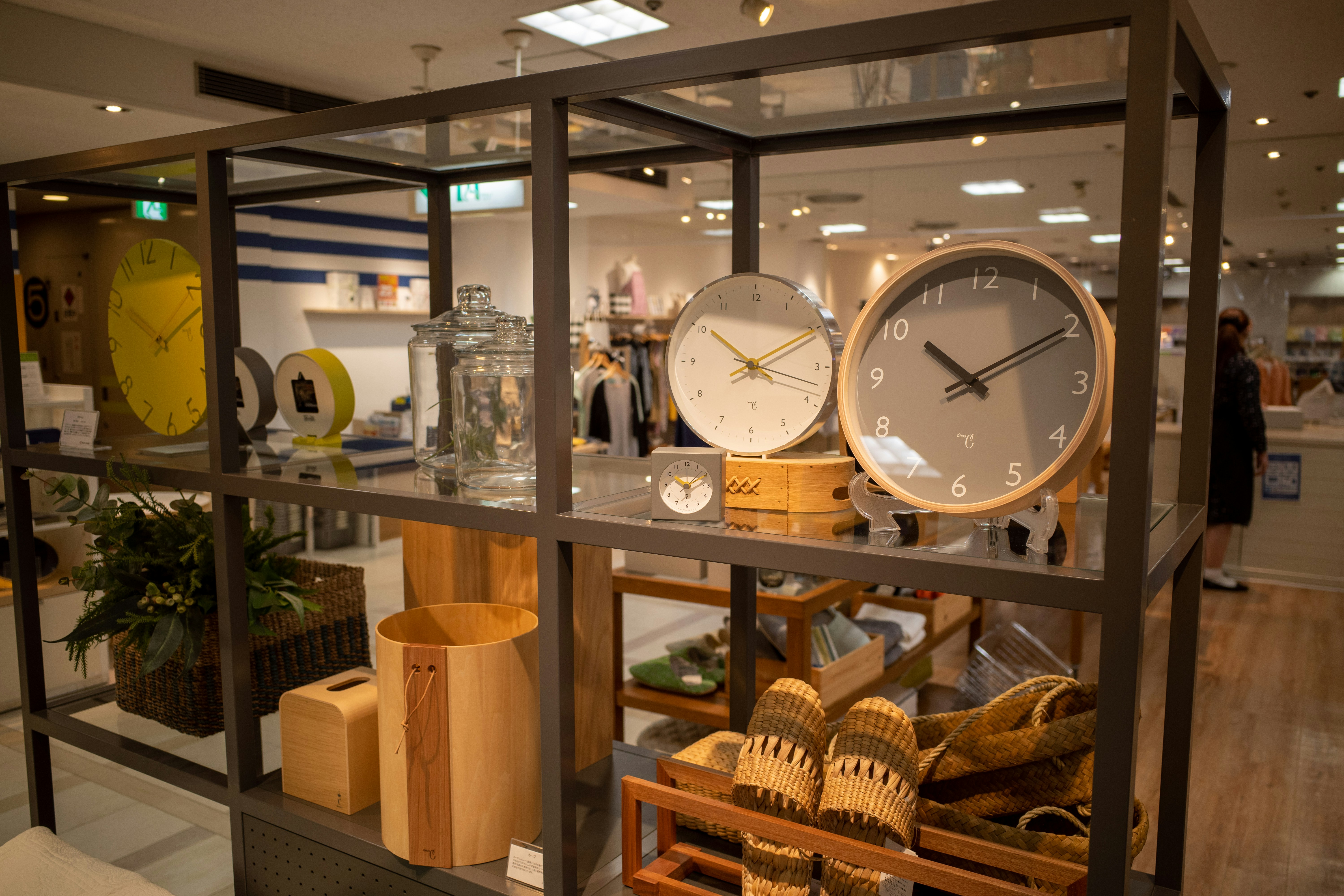 Clockwork Shelf: Timepieces and Wooden Accents in a Bright Shop