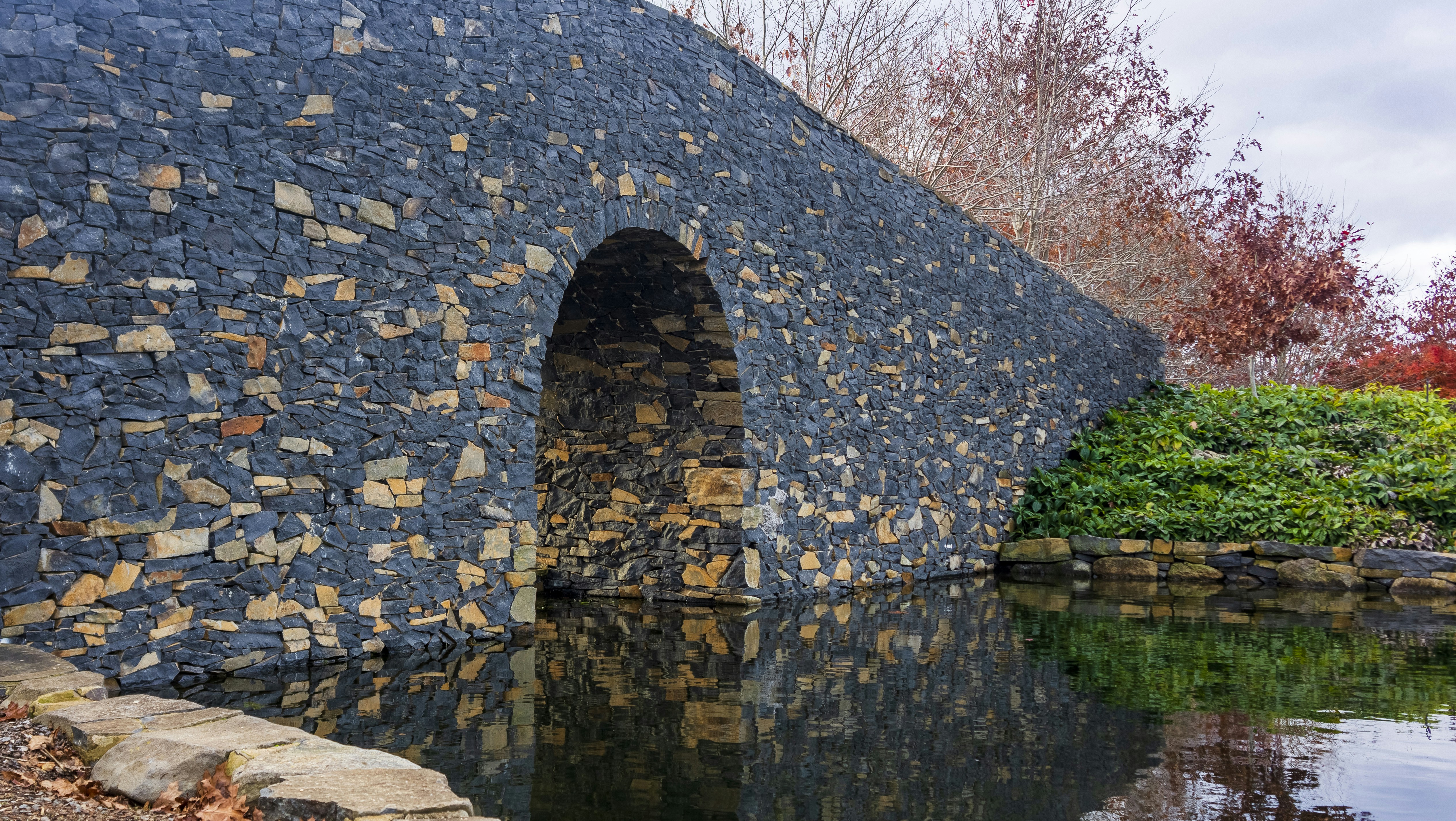 Arched Stone Bridge Framed by Autumn Reflections