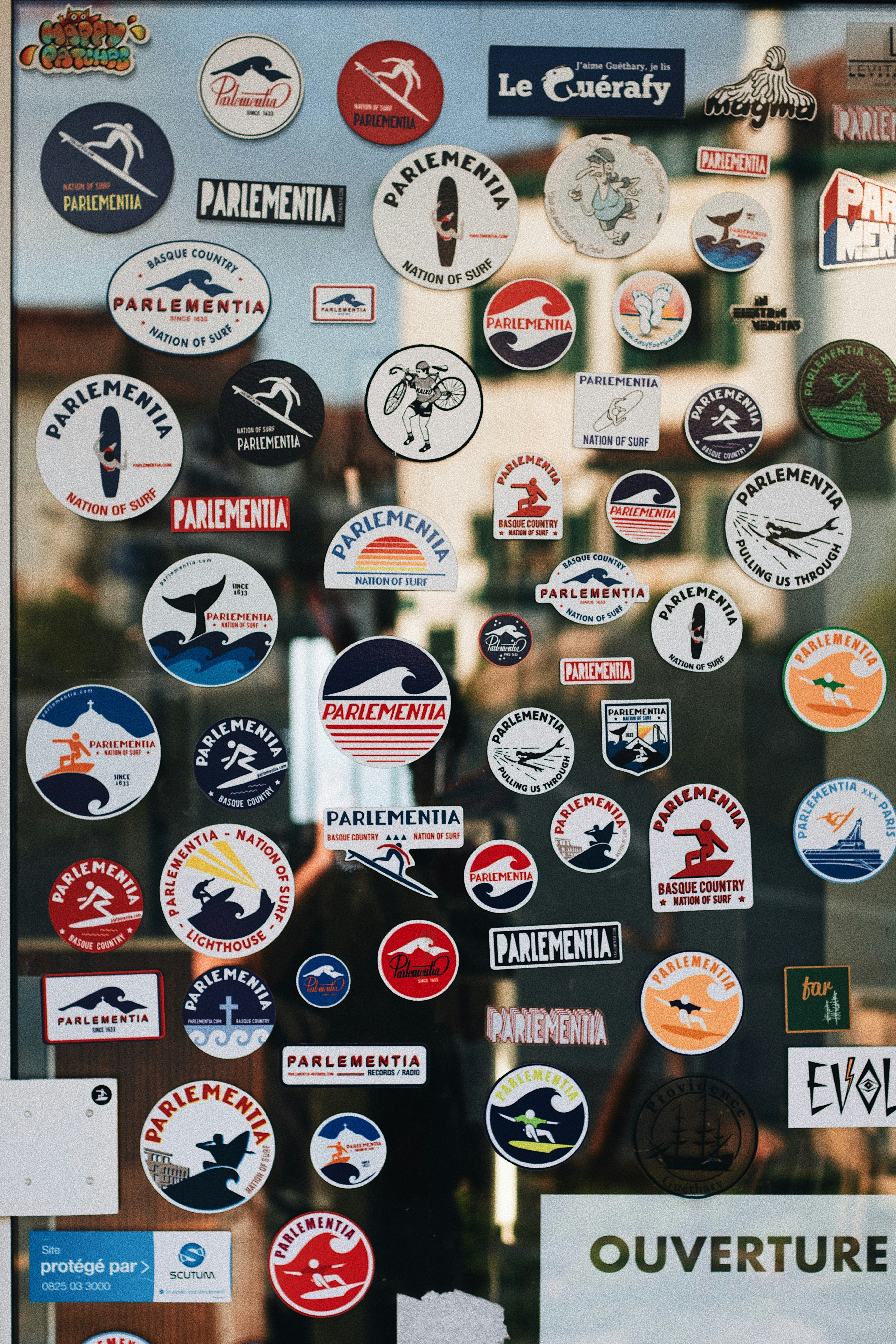 A bunch of stickers on a glass door photo – Free Logo Image on Unsplash