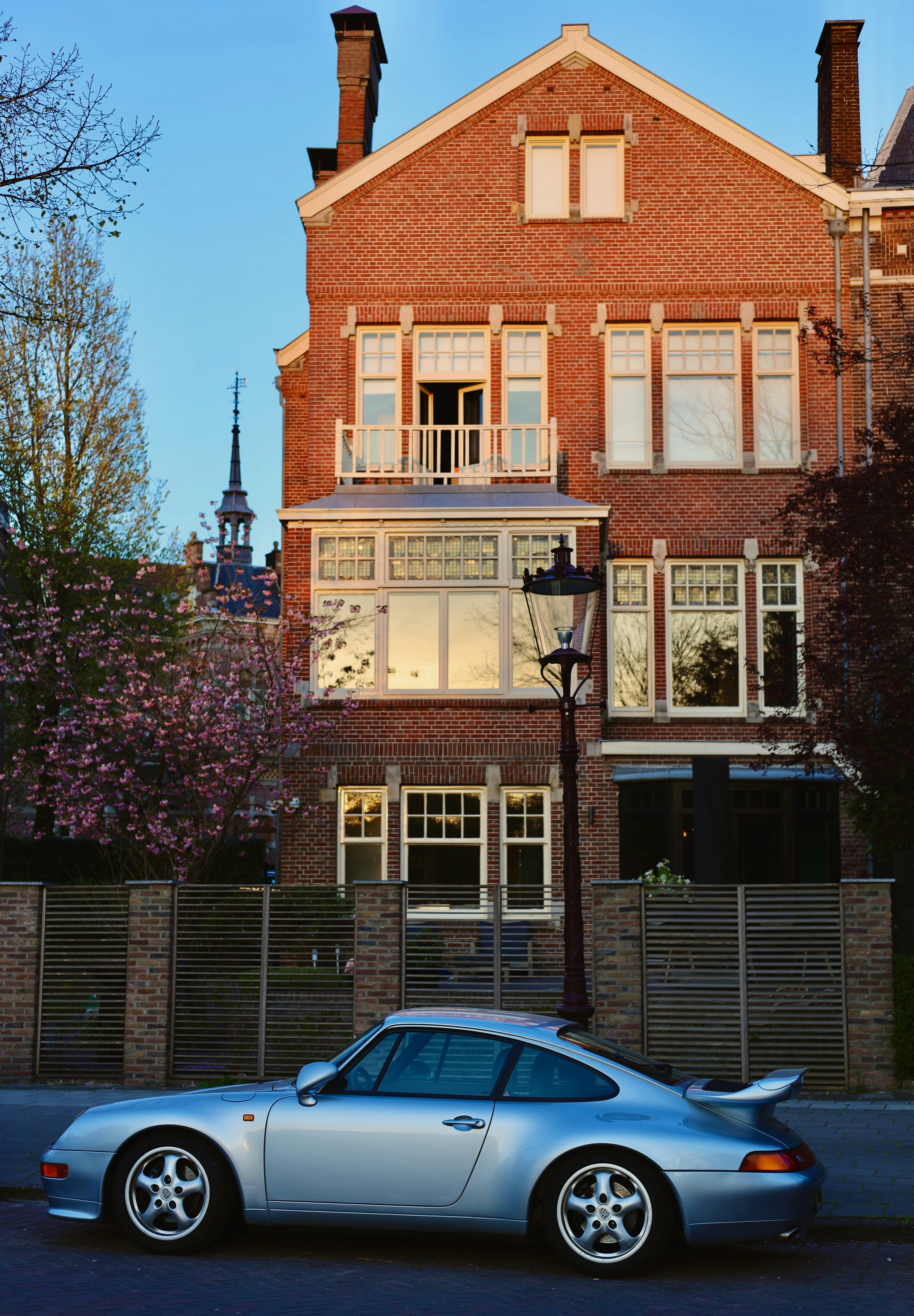 Azure Porsche Meets a Brick Townhouse: Afternoon Quiet on the Street