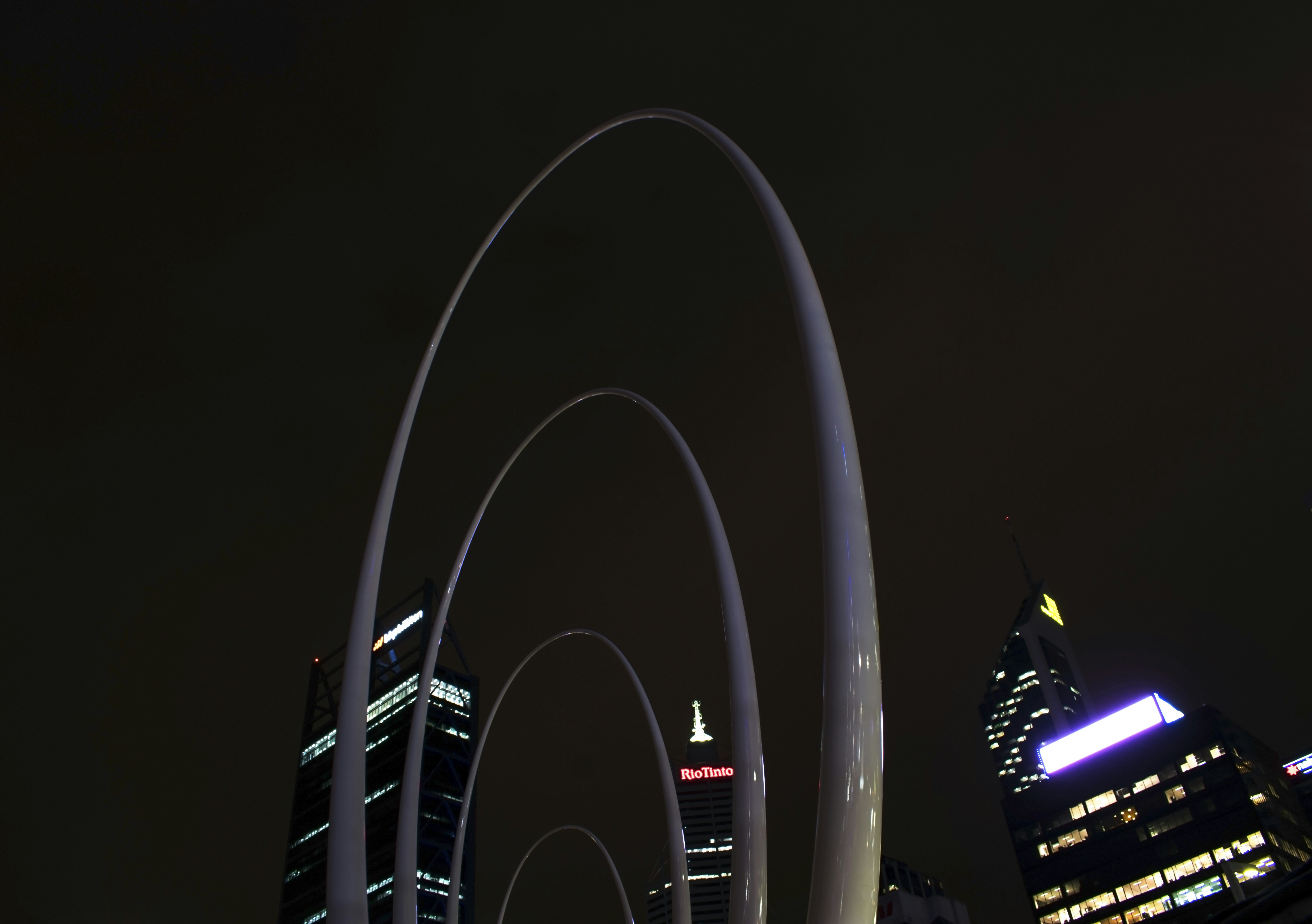 Concentric Night Arcs Framing a Neon Skyline
