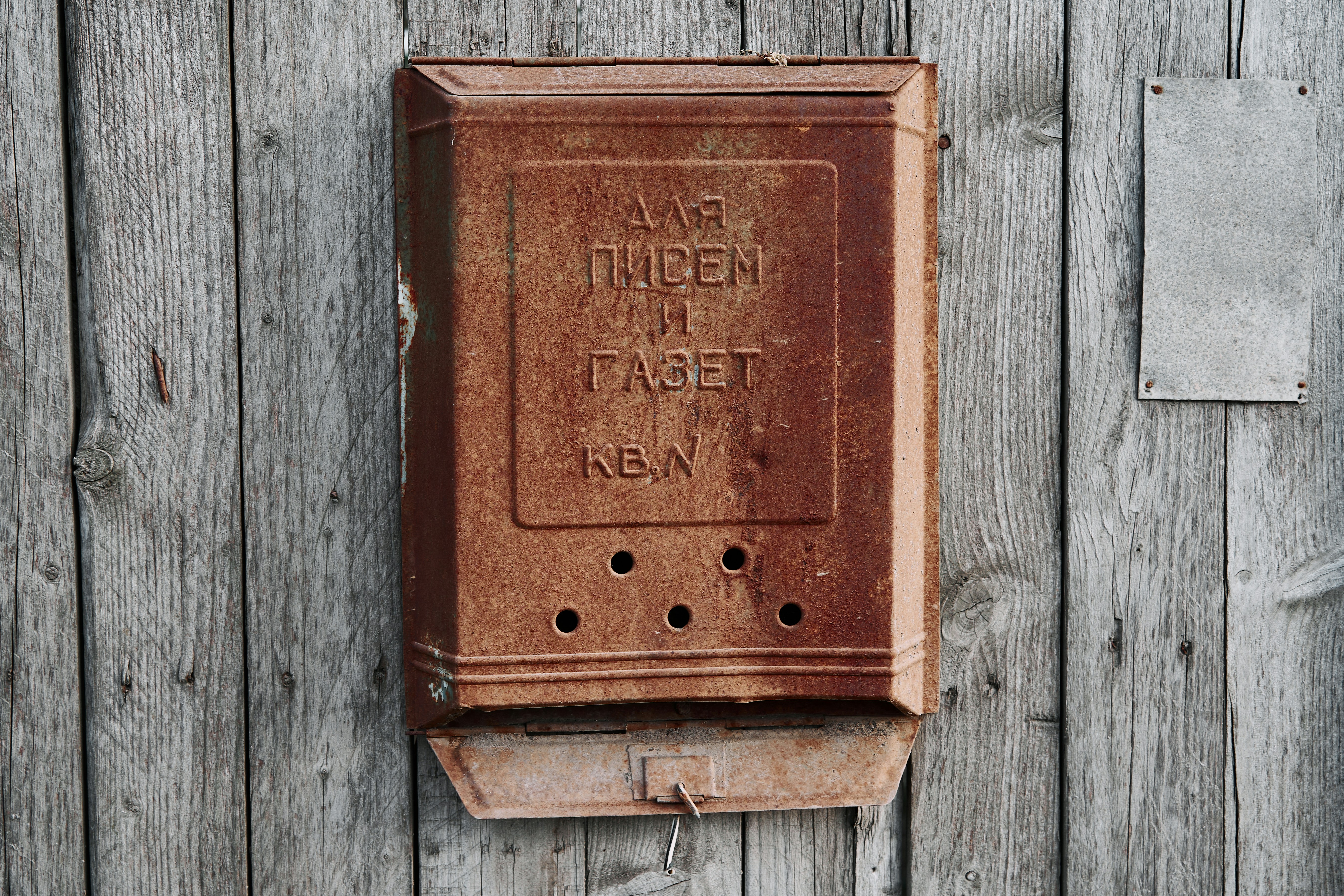 Rustic Mailbox on Weathered Wooden Fence