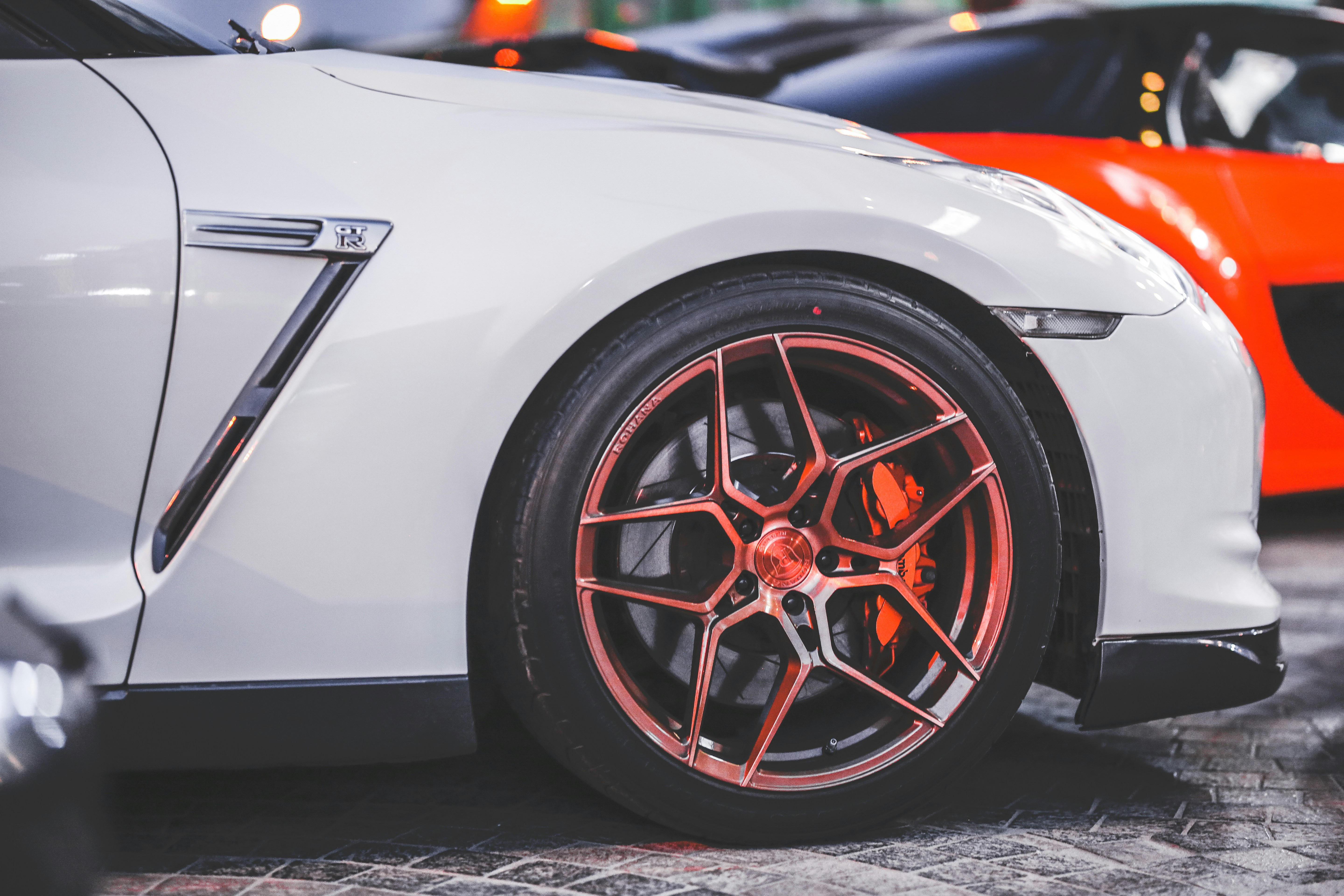 A close up of a white sports car with red spokes photo – Free Rims and ...