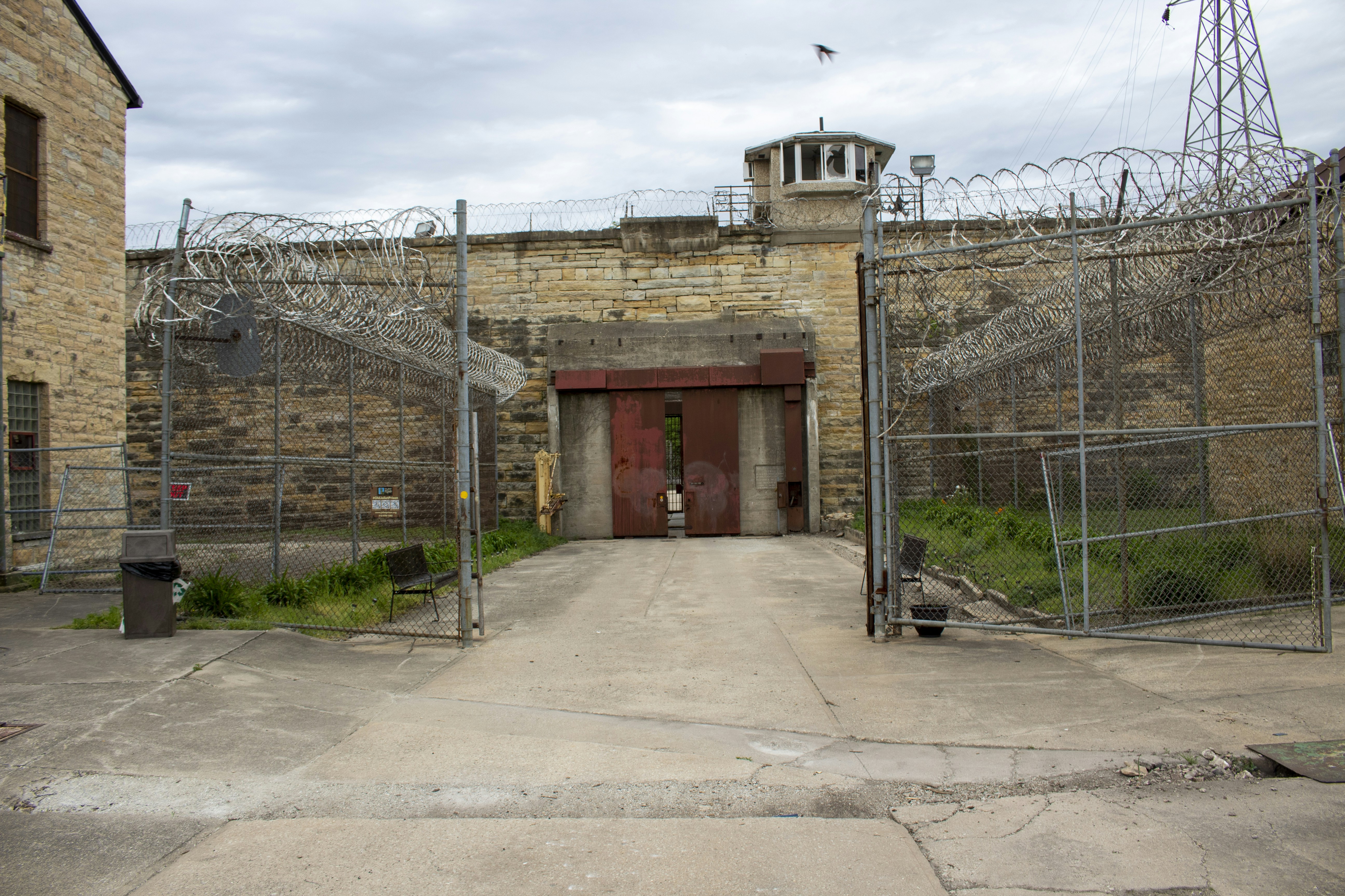 a gated entrance to a building with a clock tower in the background
