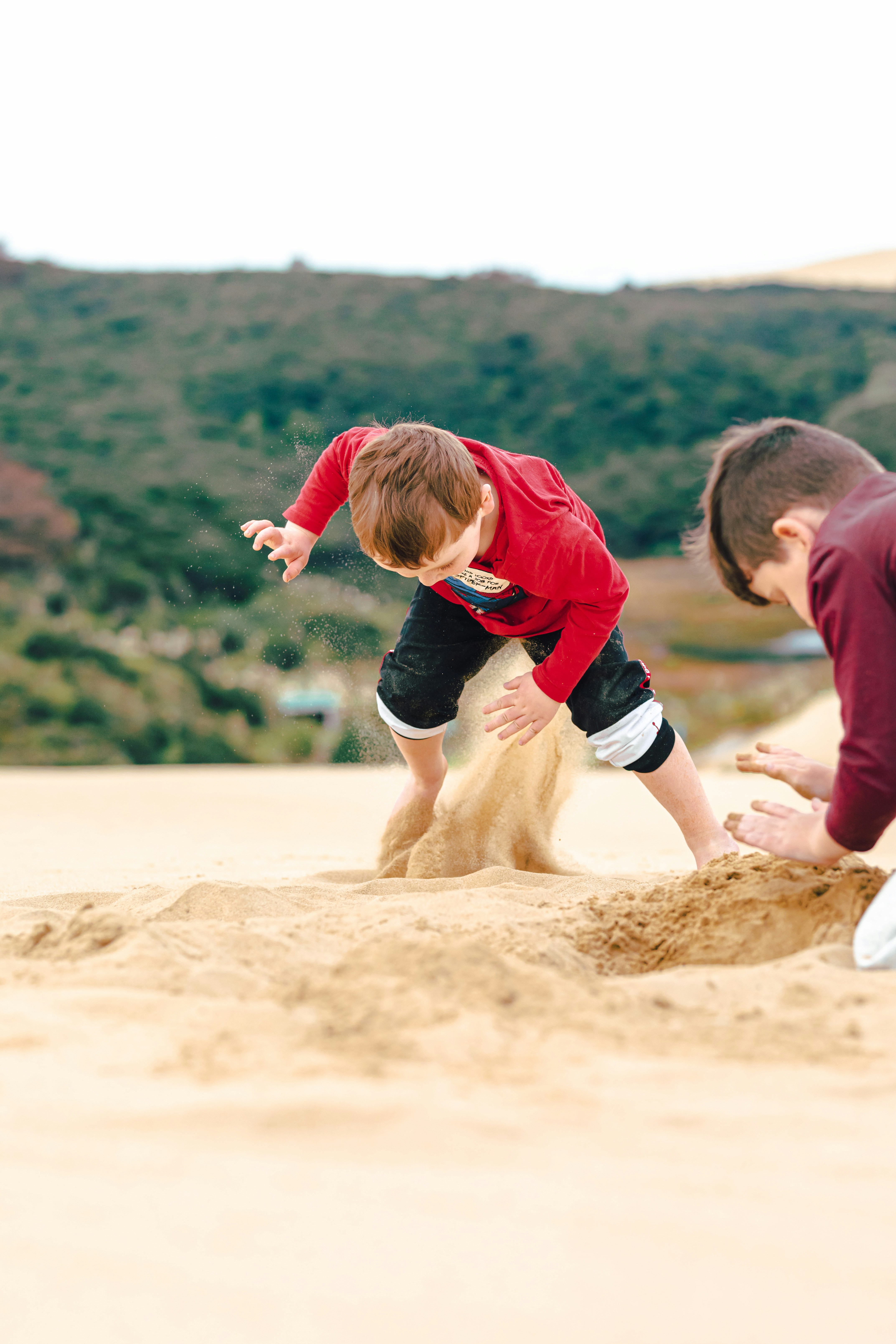 Red-Shirt Leap: Two Boys Build a Sand Hill at the Beach