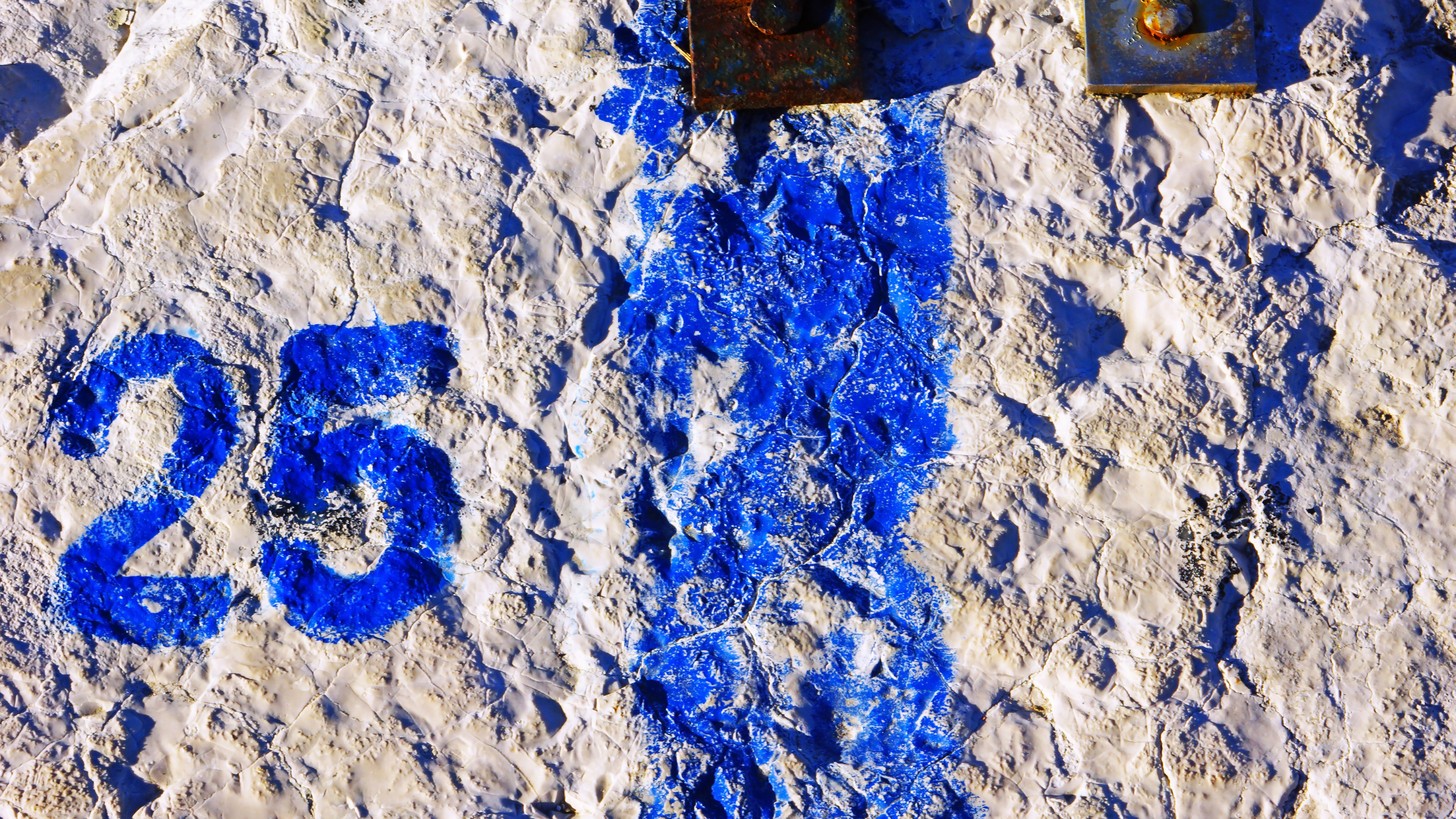 Blue Paint Streak over Rough Concrete: A Close Rappel of Texture and Color