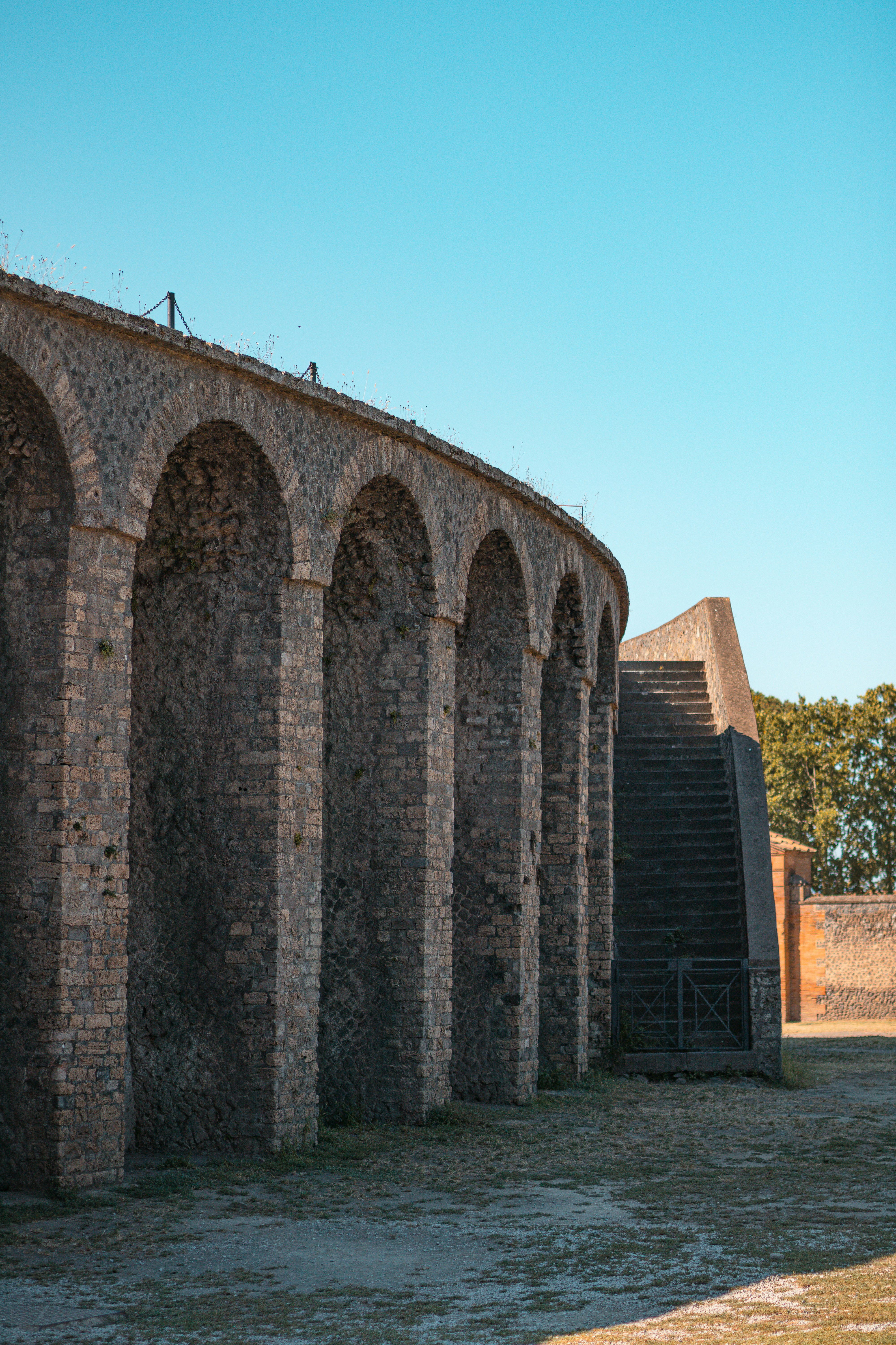 A row of stone arches sitting next to each other photo – Free Blue ...