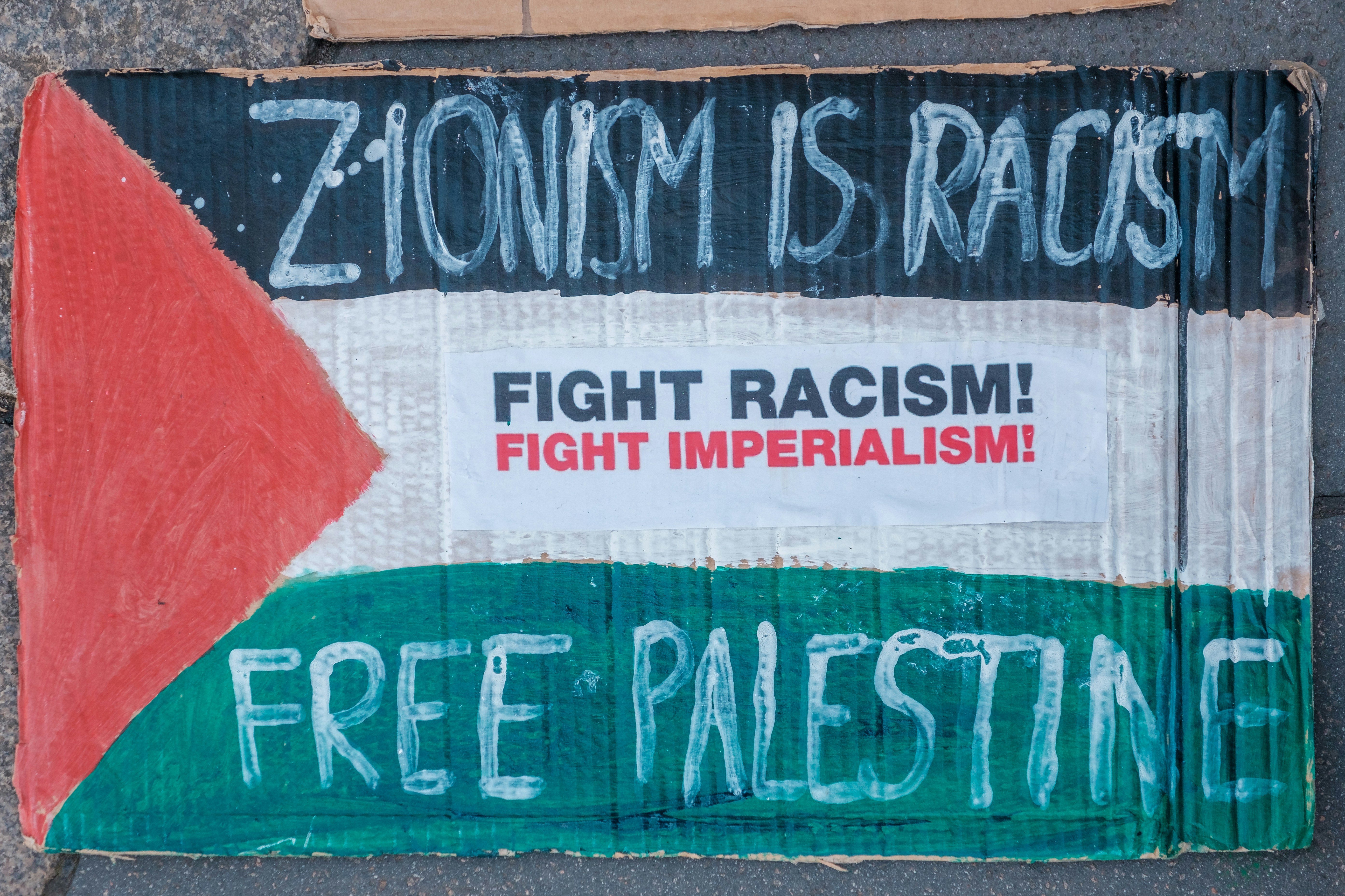 A sign on the side of a building with a free palestine message photo ...