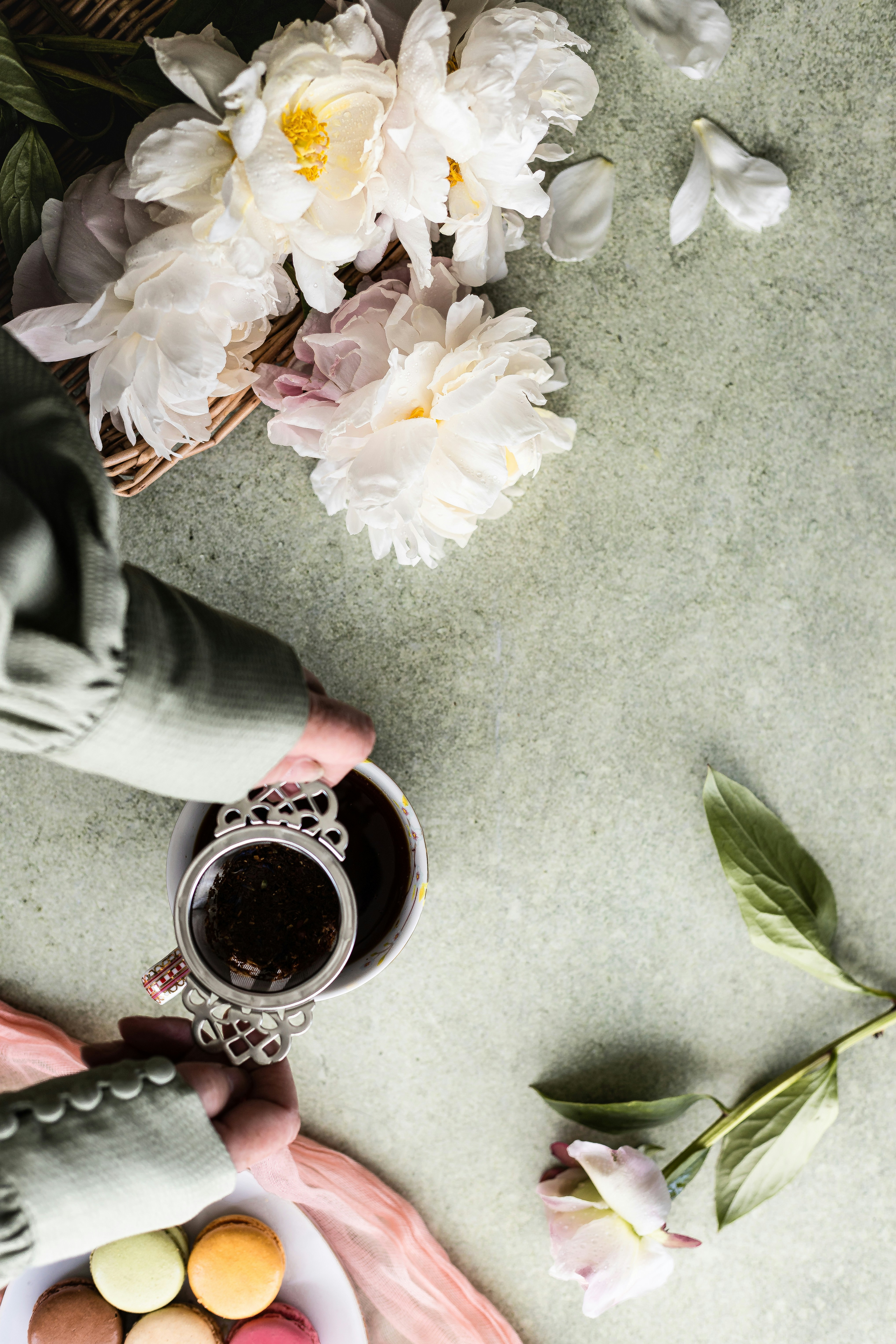 Tea Amid Peonies: A Quiet Moment on a Textured Table