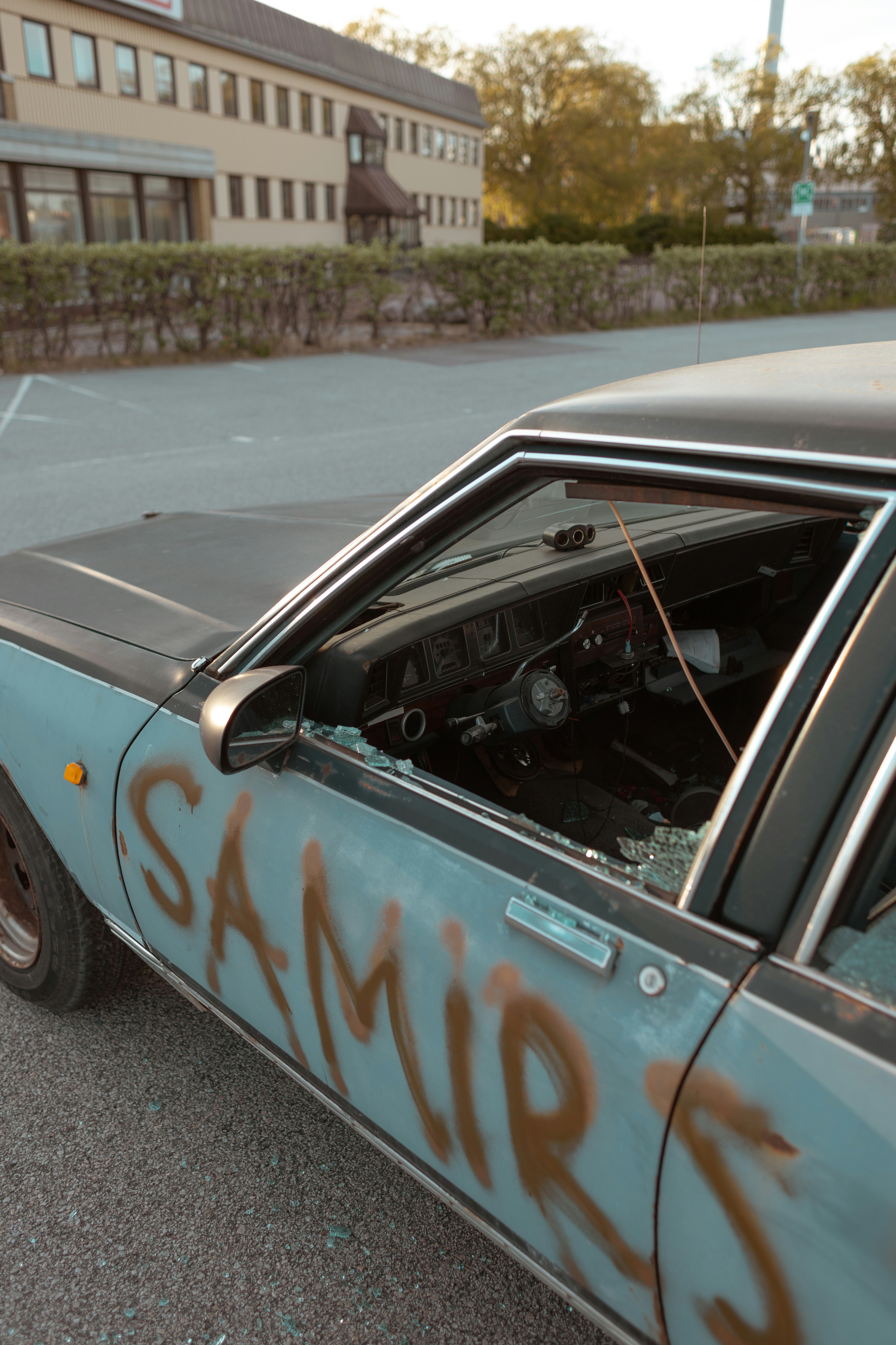Blue Sedan Graffiti: A Decayed Moment in the Parking Lot