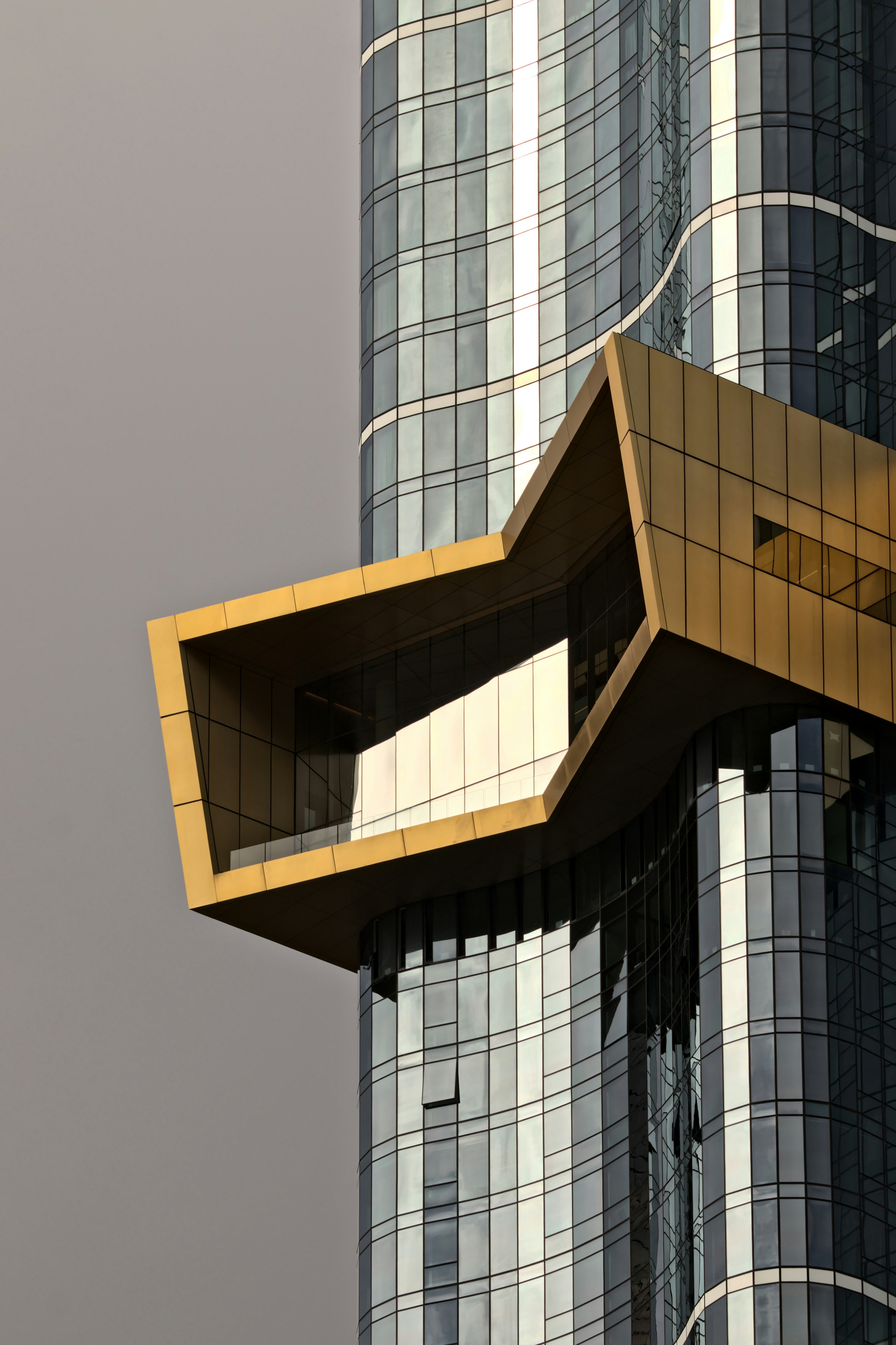 Gold Cantilever: A Geometric Sculpture Claimed by a Glass Skyscraper