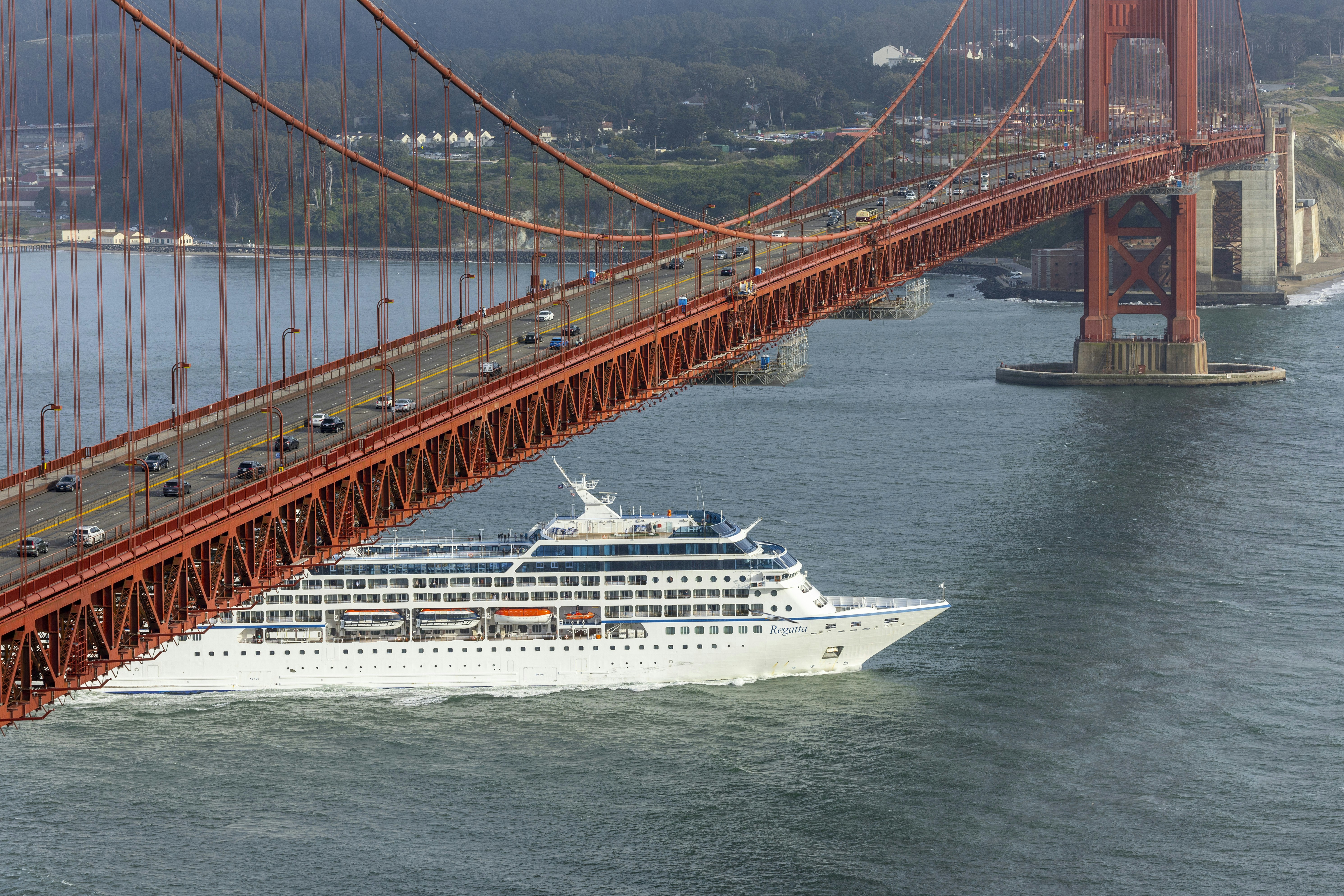 A cruise ship passing under the golden gate bridge photo – Free ...