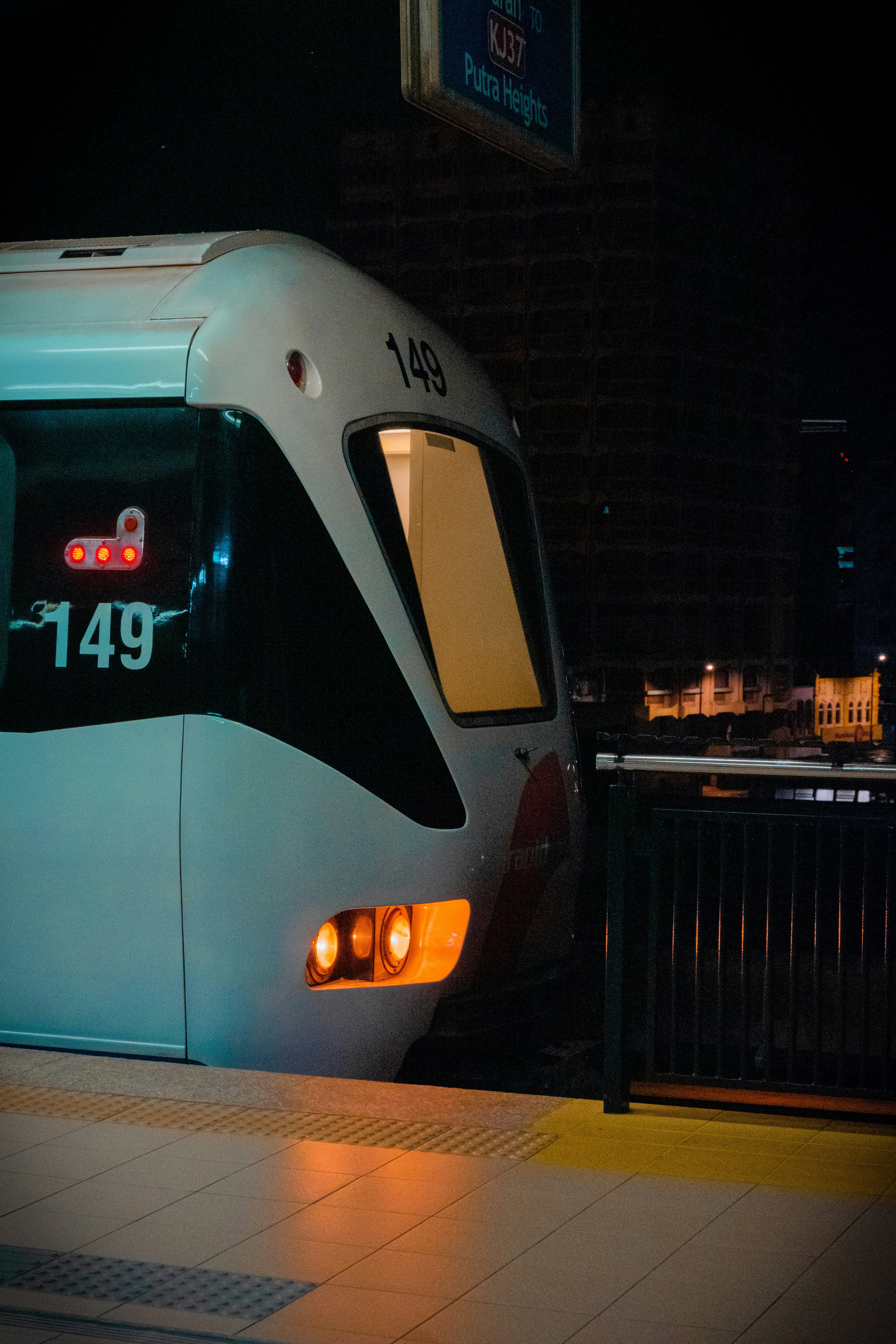 A subway train stopped at a station at night photo – Free Lrt pasar ...
