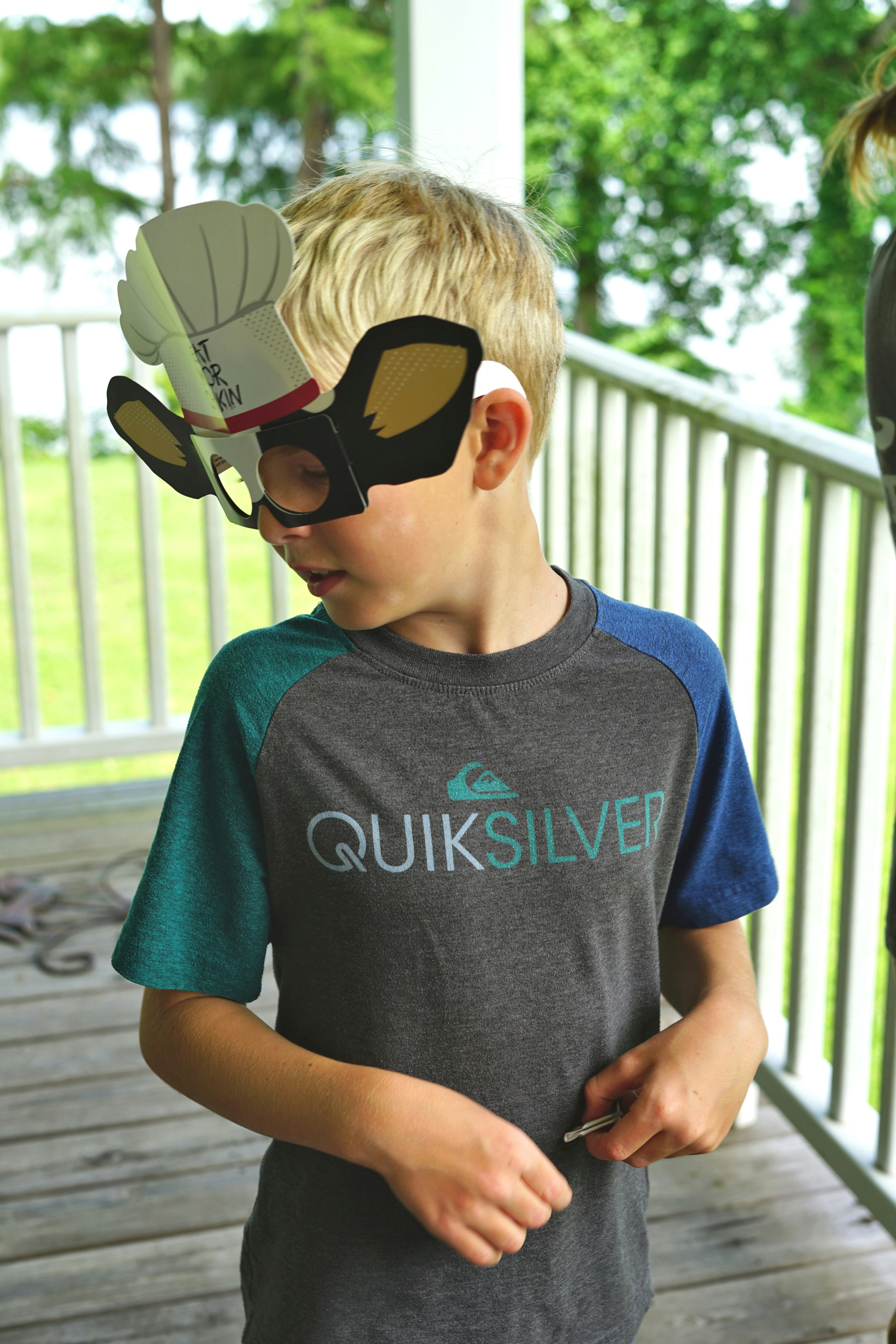 Masked Side Glance: A Boy in a Masked Afternoon
