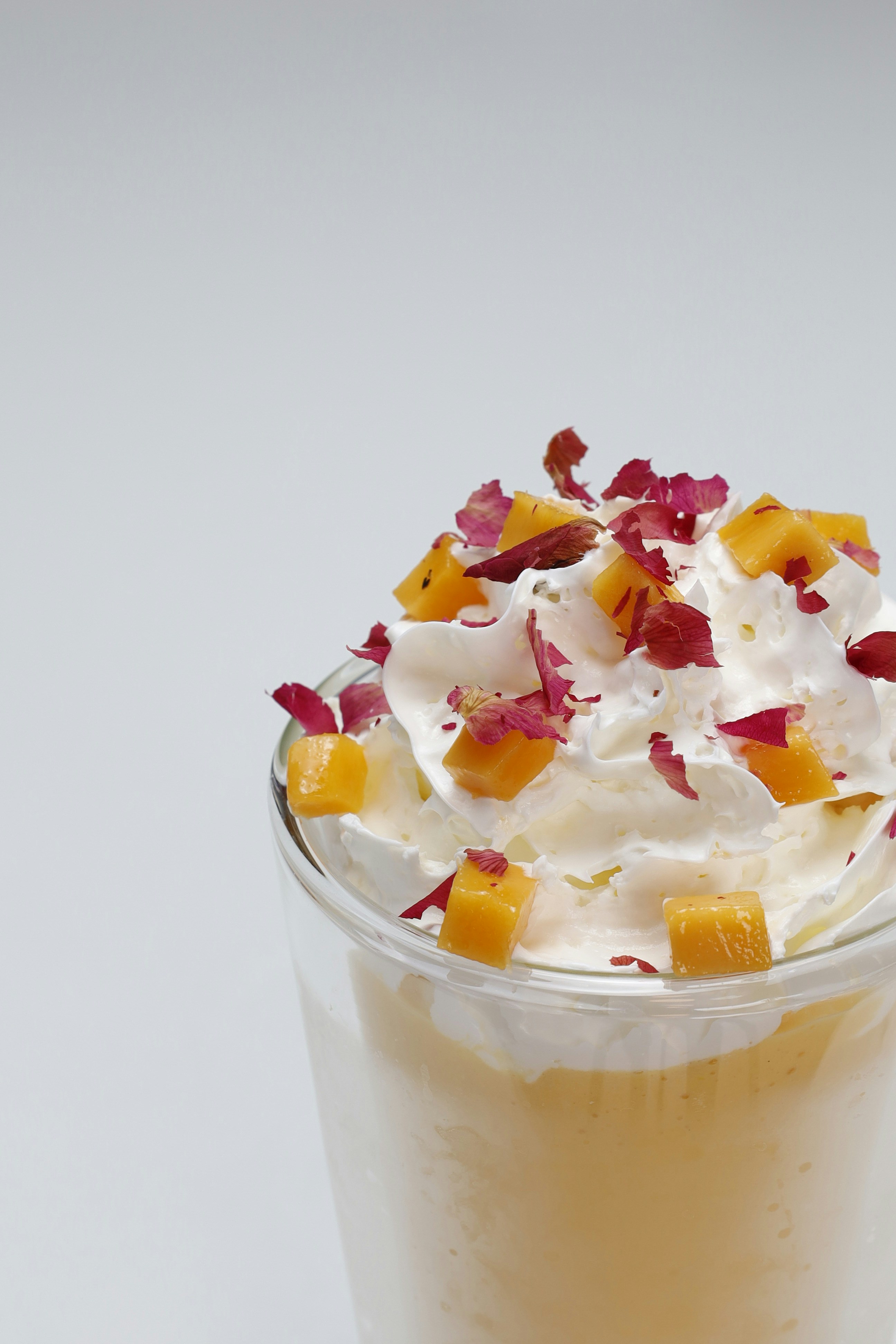 Cream Crown over Mango Dice: A Rose-Petal Dessert Portrait