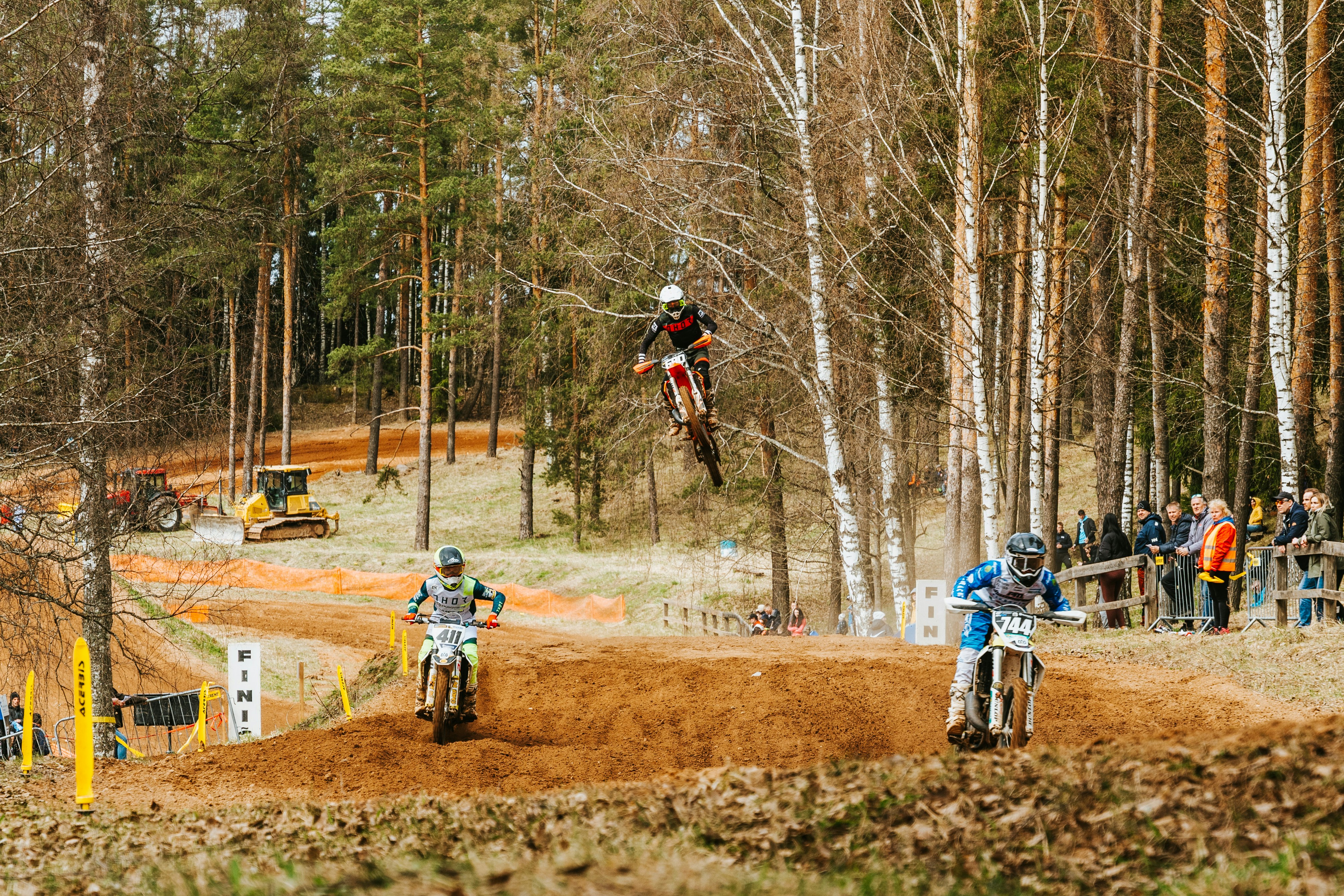 A group of people riding dirt bikes on a dirt track photo – Free ...