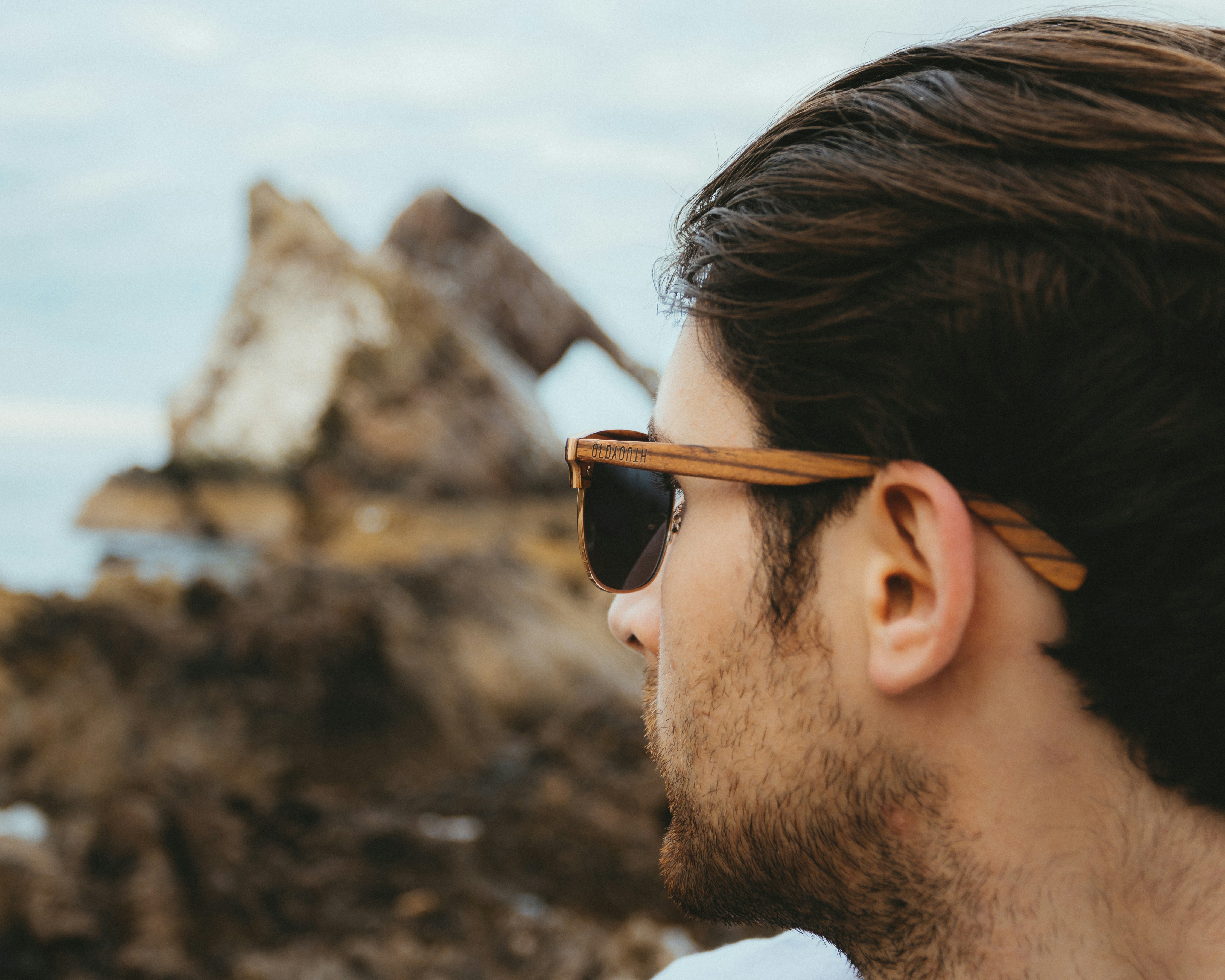 Gaze at the Edge: Seaside Portrait by Ragged Rocks