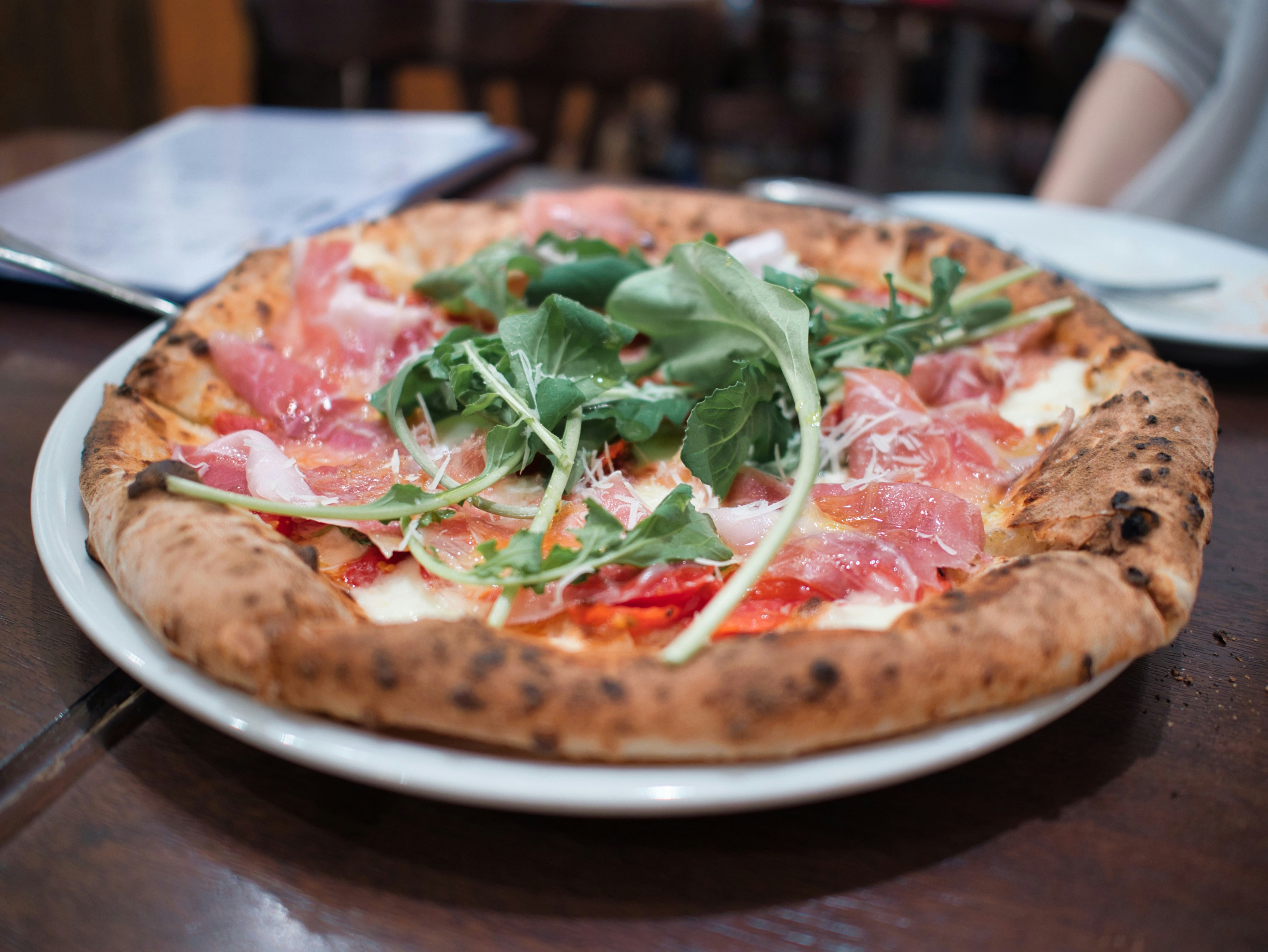 A close up of a pizza on a plate on a table photo – Free Food Image on ...