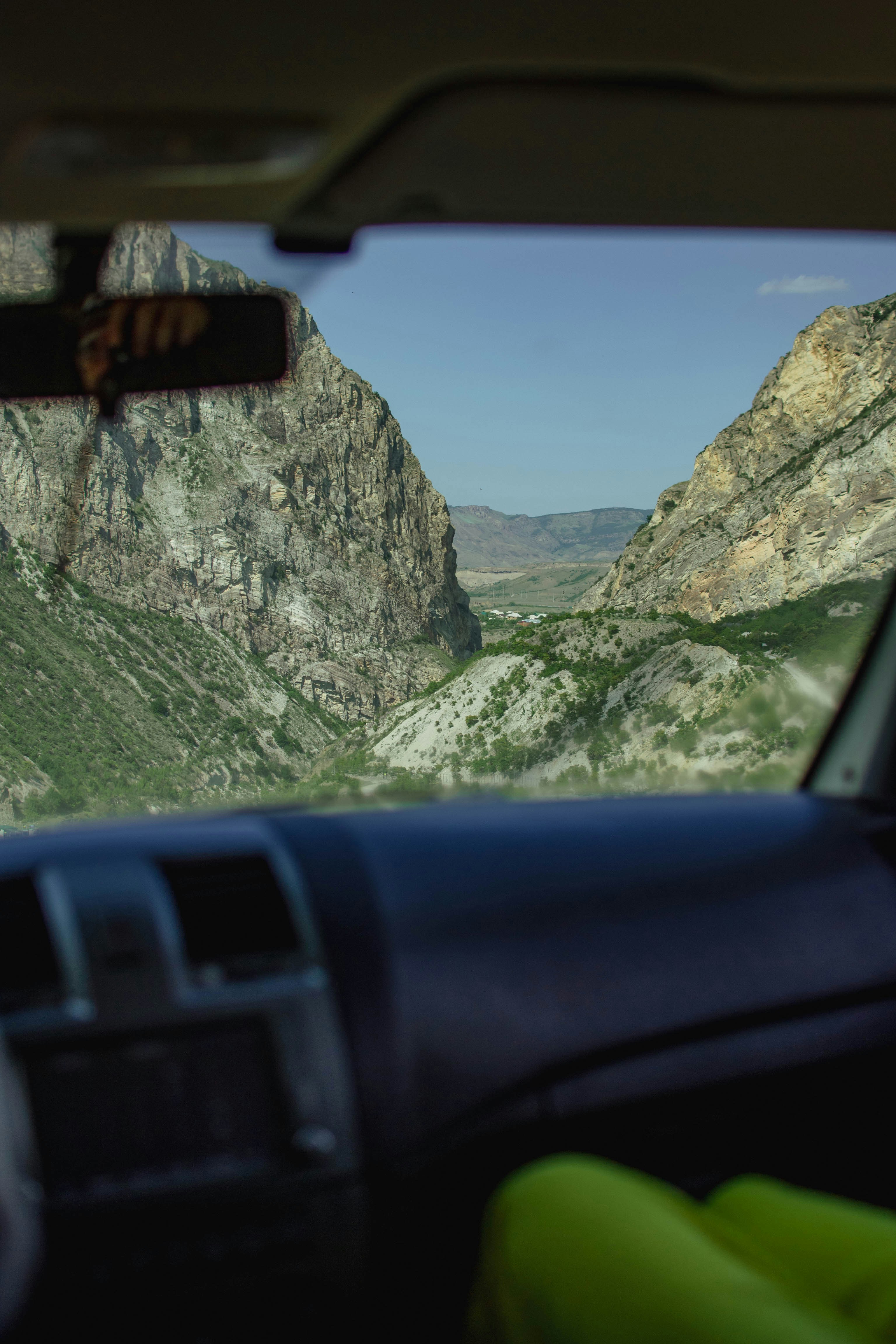 a view of mountains from inside a car