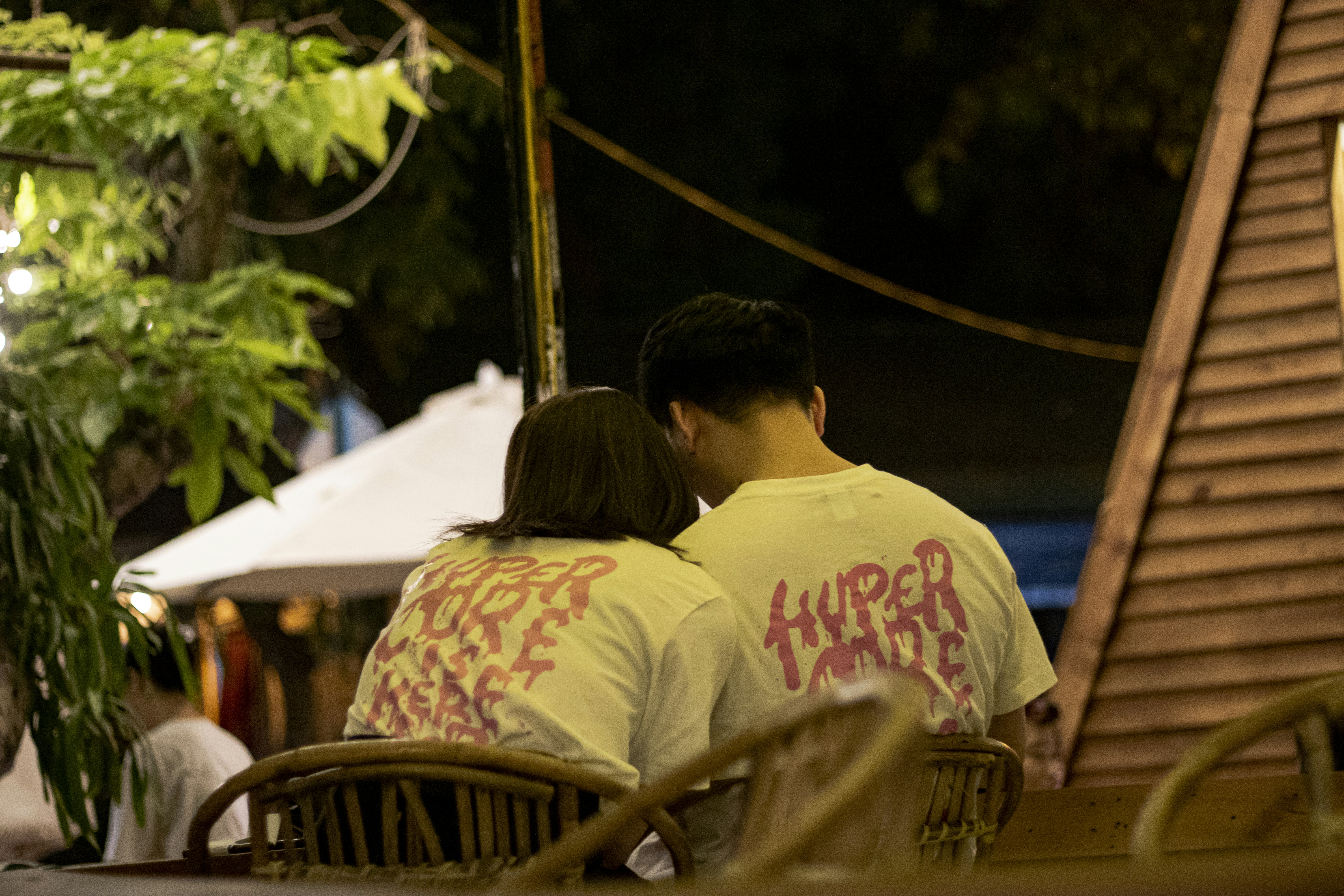 Two Friends in a Night Café: Close Comfort Under Warm Lights