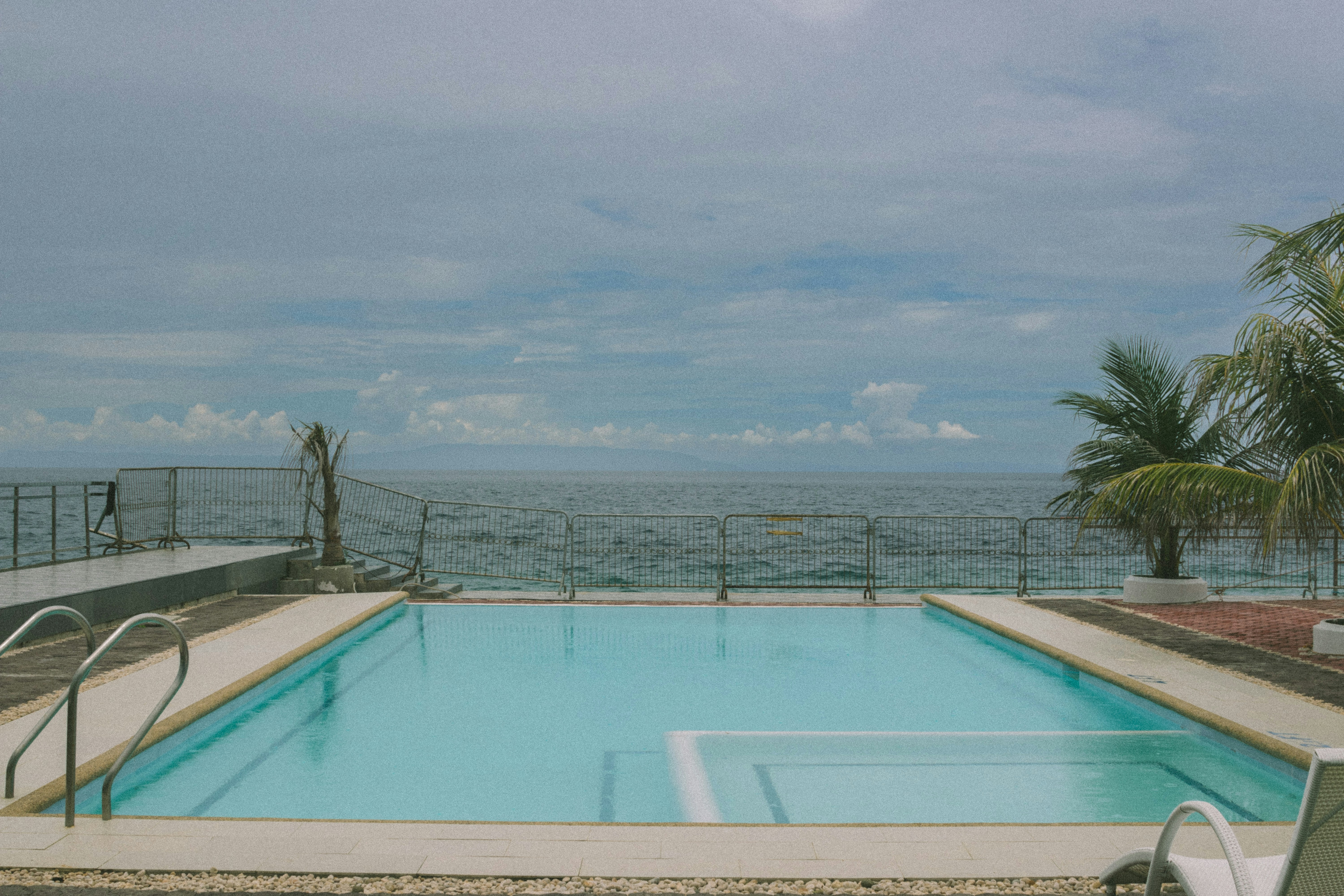 An empty swimming pool with a view of the ocean photo – Free Building ...