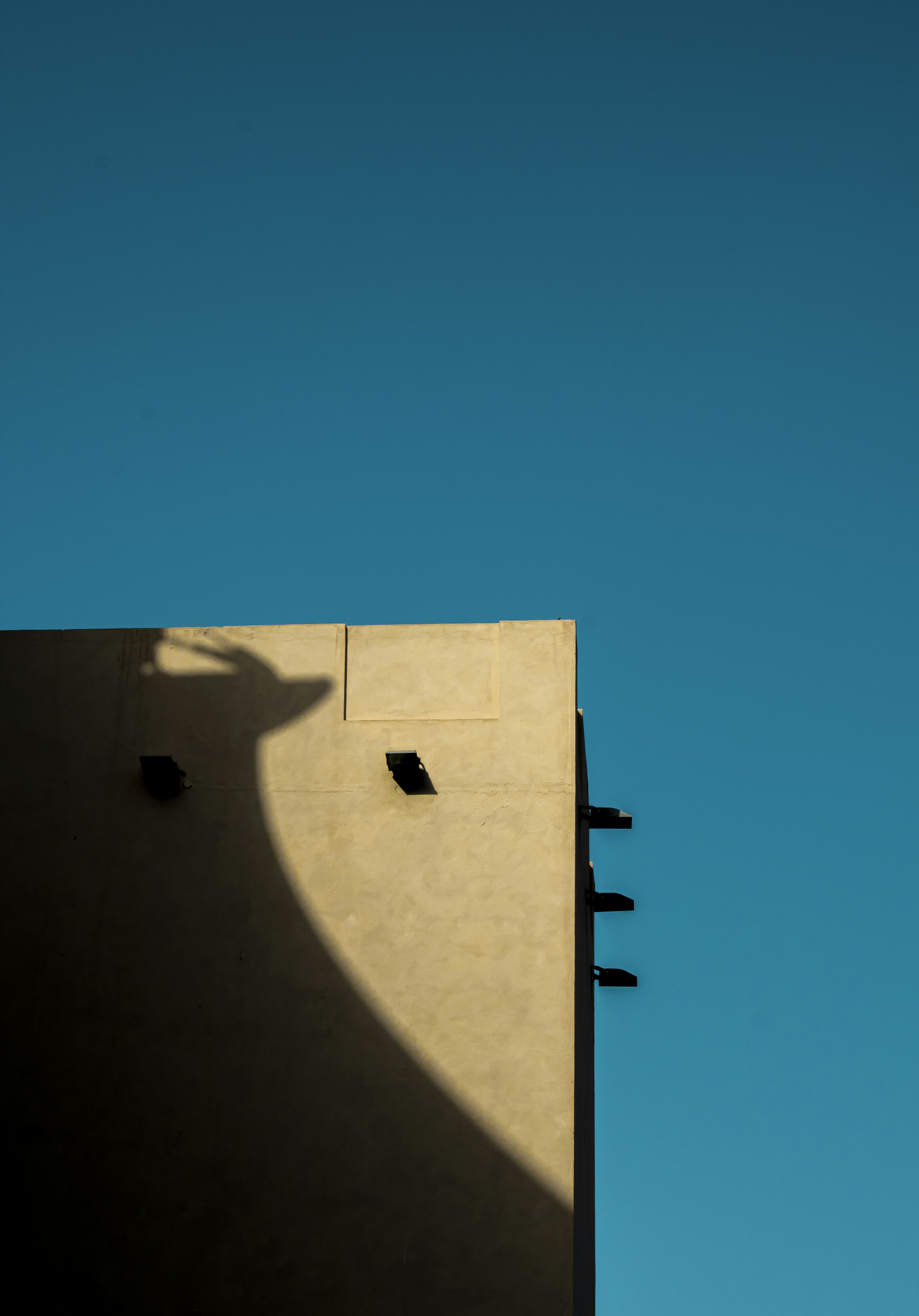 A shadow of a person on a building photo – Free Abu dhabi - united arab ...