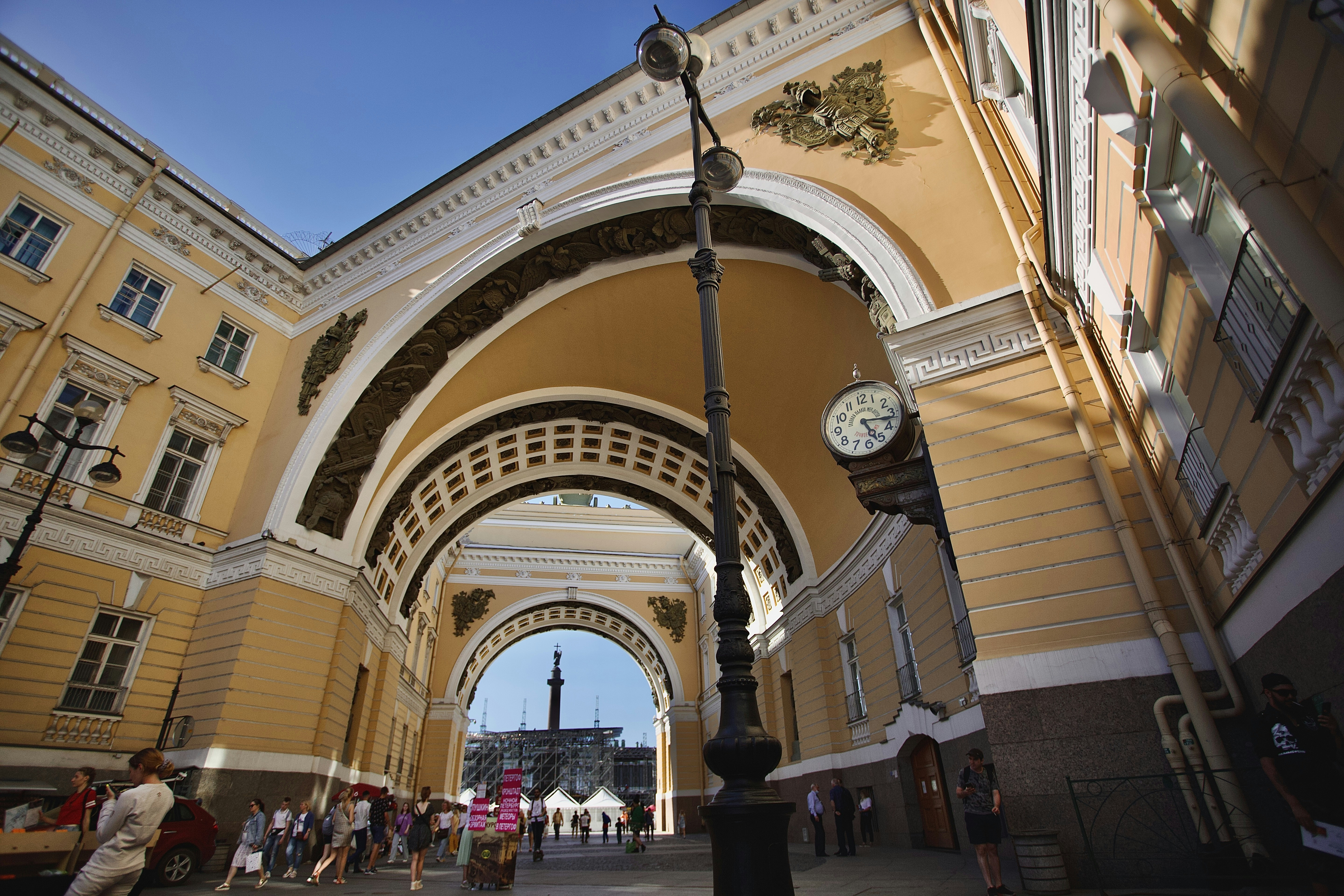 Sunlit Arcades: A Golden Archway Framing a Busy Plaza