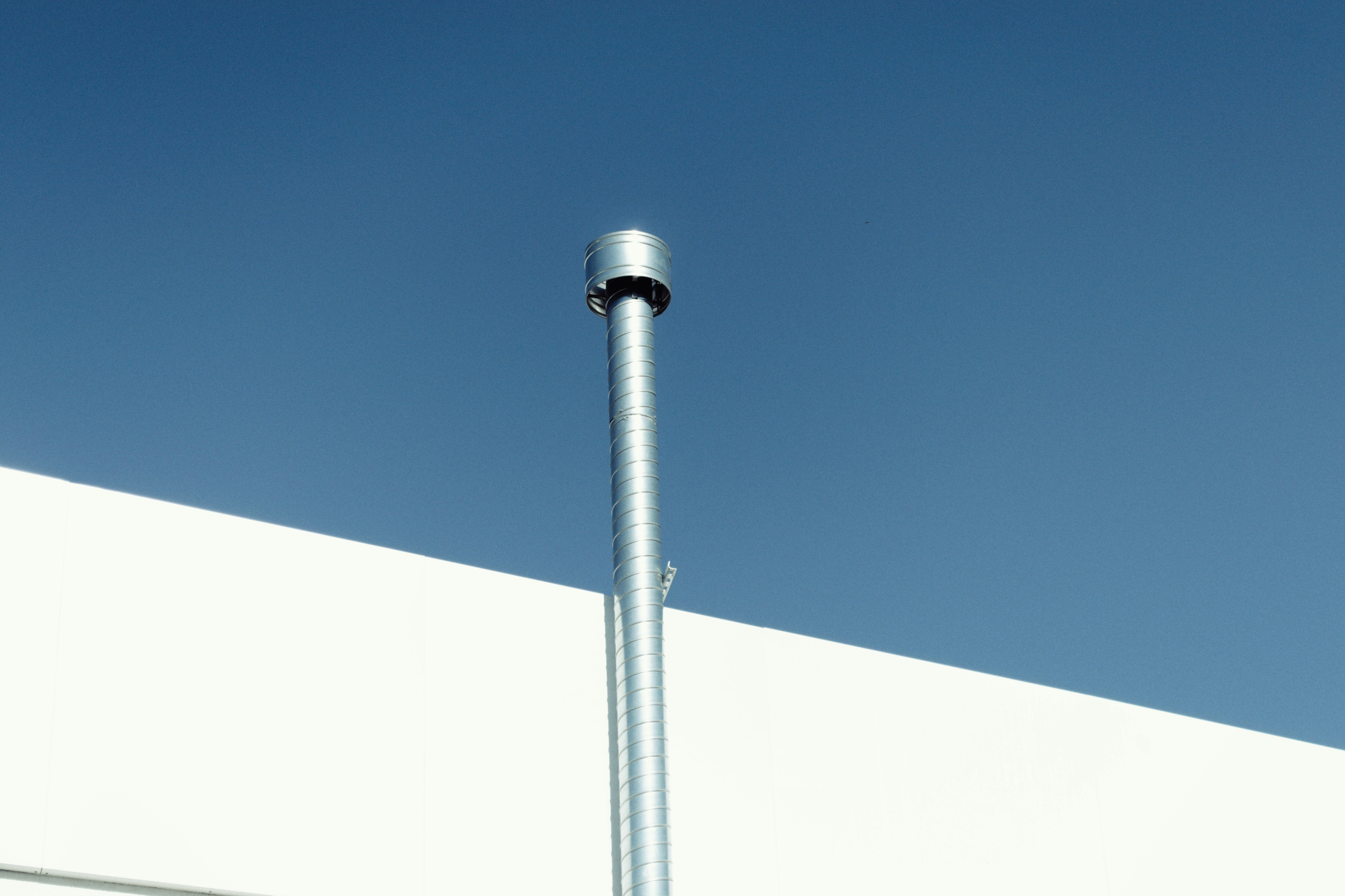 Vertical Chimney Crown Against a Cerulean Sky