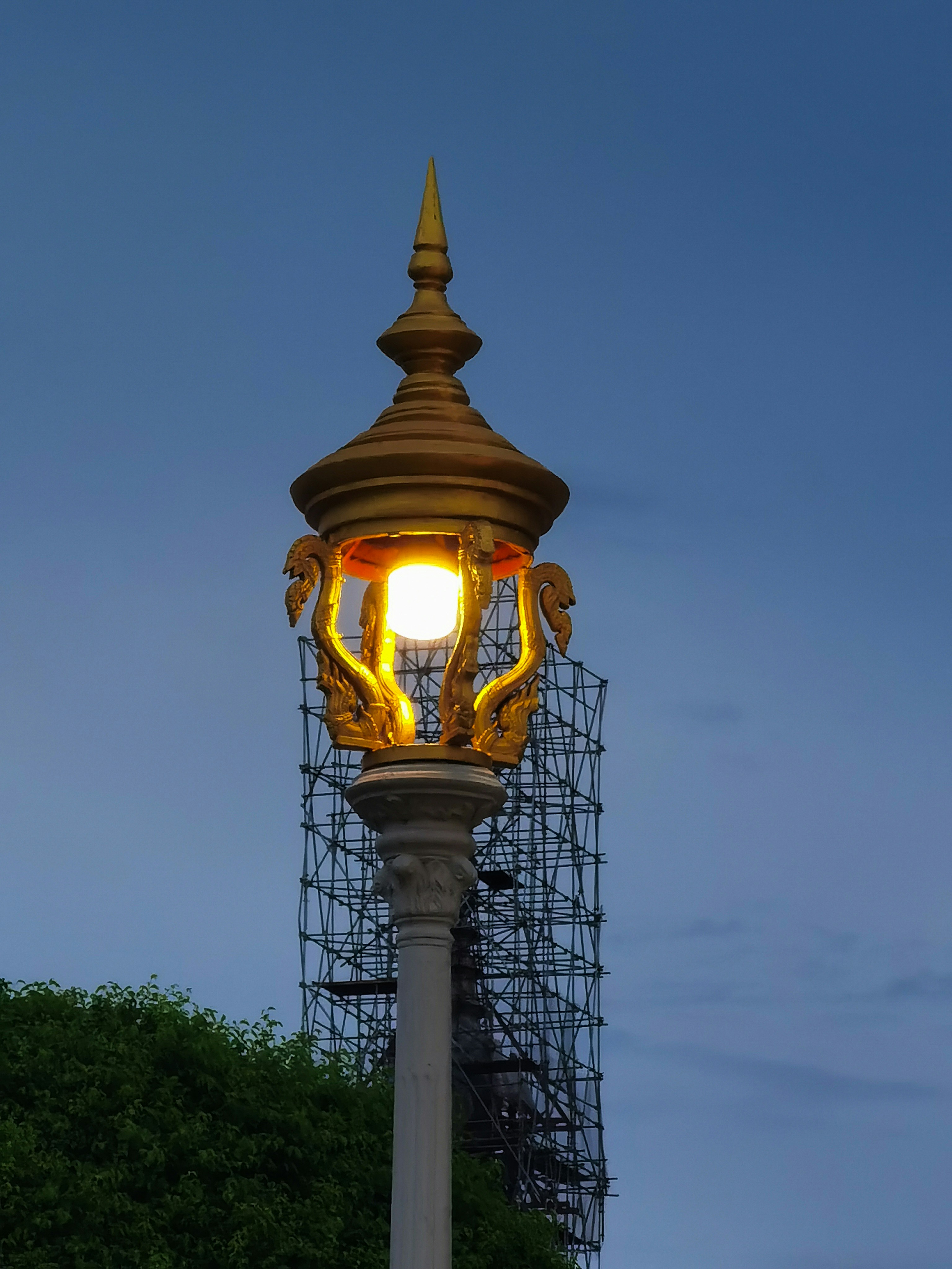 Golden Lantern at Dusk: Ornate Lamp Post Against a Clear Sky