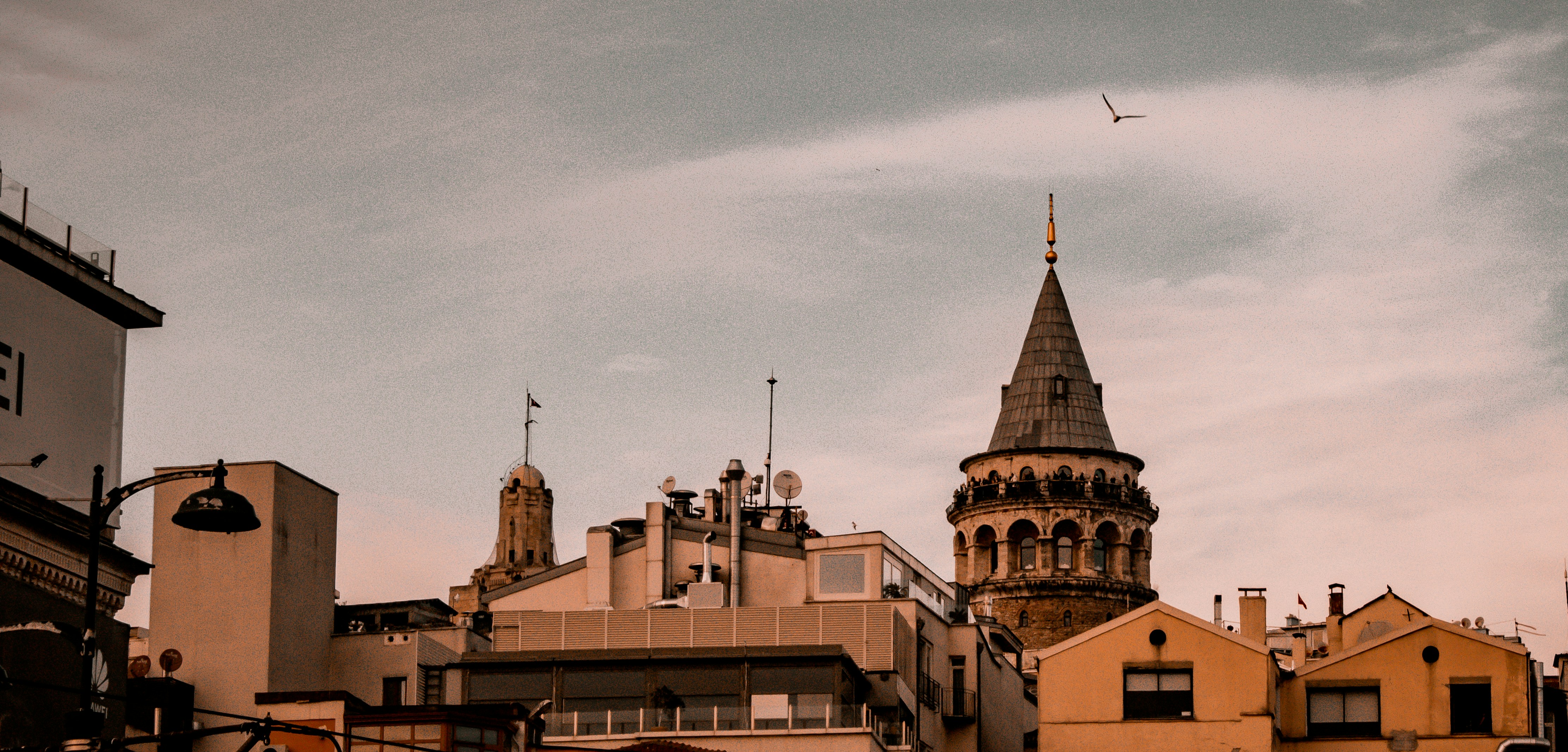 Dusk over Istanbul's Galata Tower: Copper Sky and Rooftop Silence