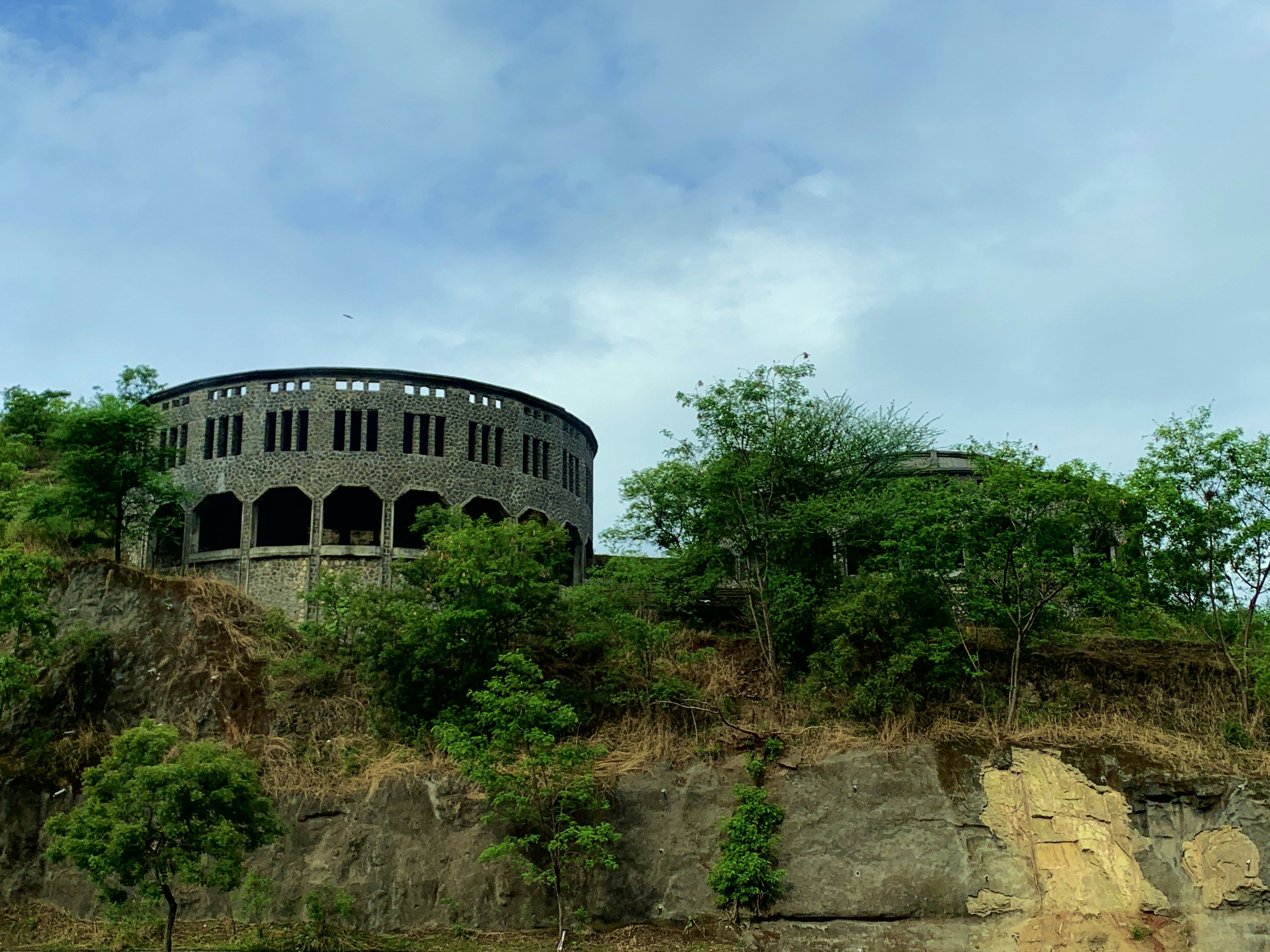 A large round building on top of a cliff photo – Free Outdoors Image on ...