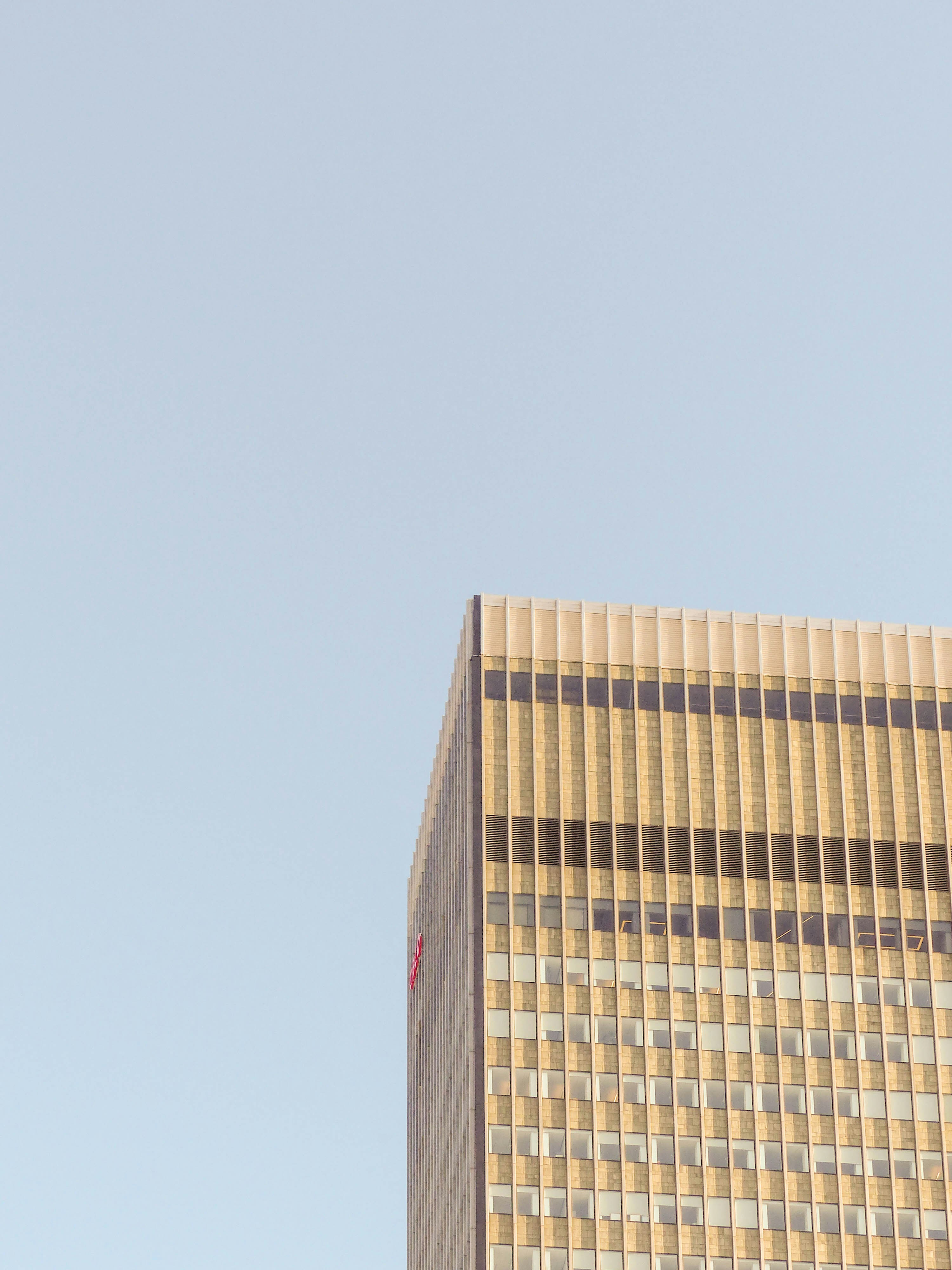 A plane flying in the sky over a tall building photo – Free Montreal ...